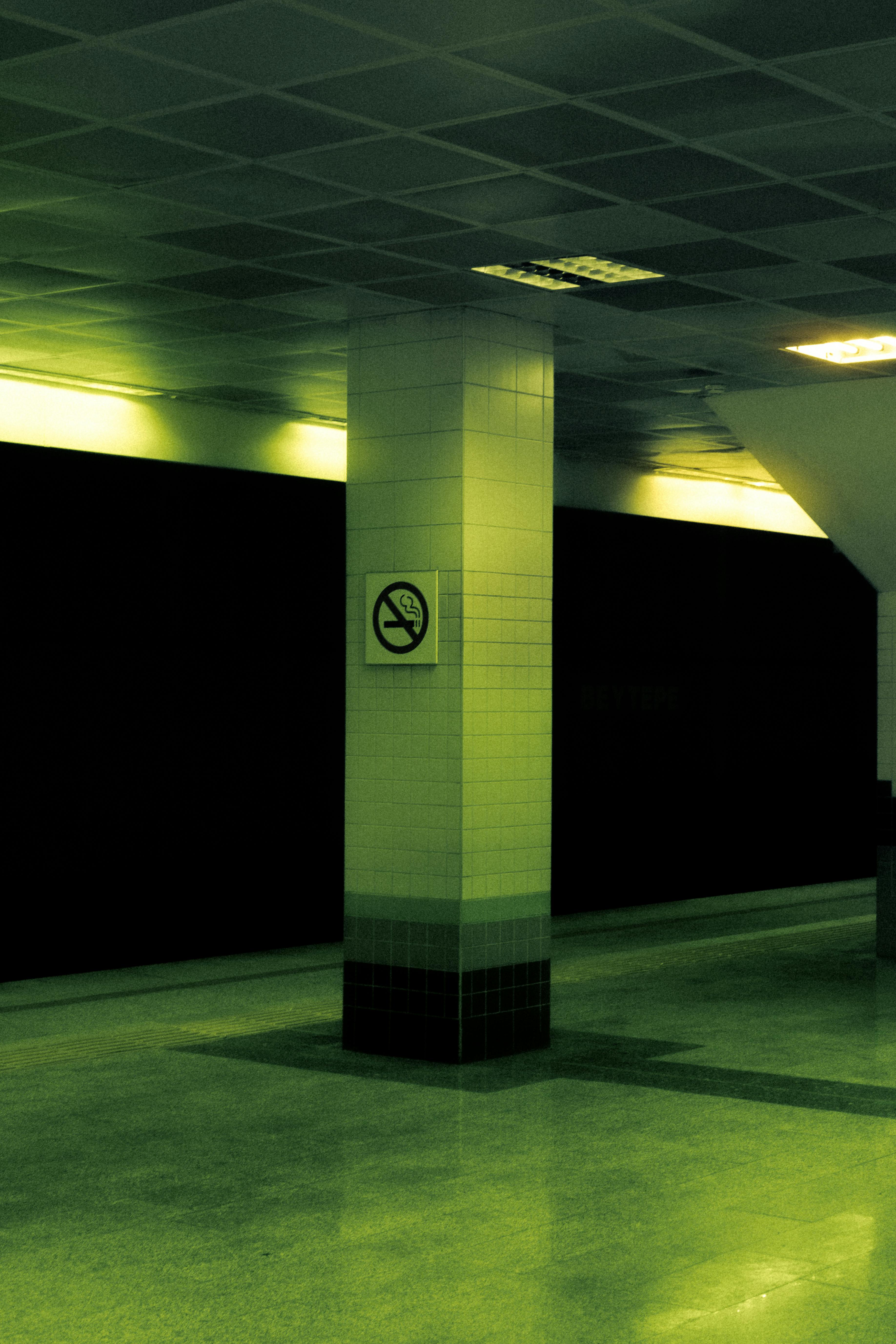 No Smoking Sign on a Pillar in a Subway Station · Free Stock Photo