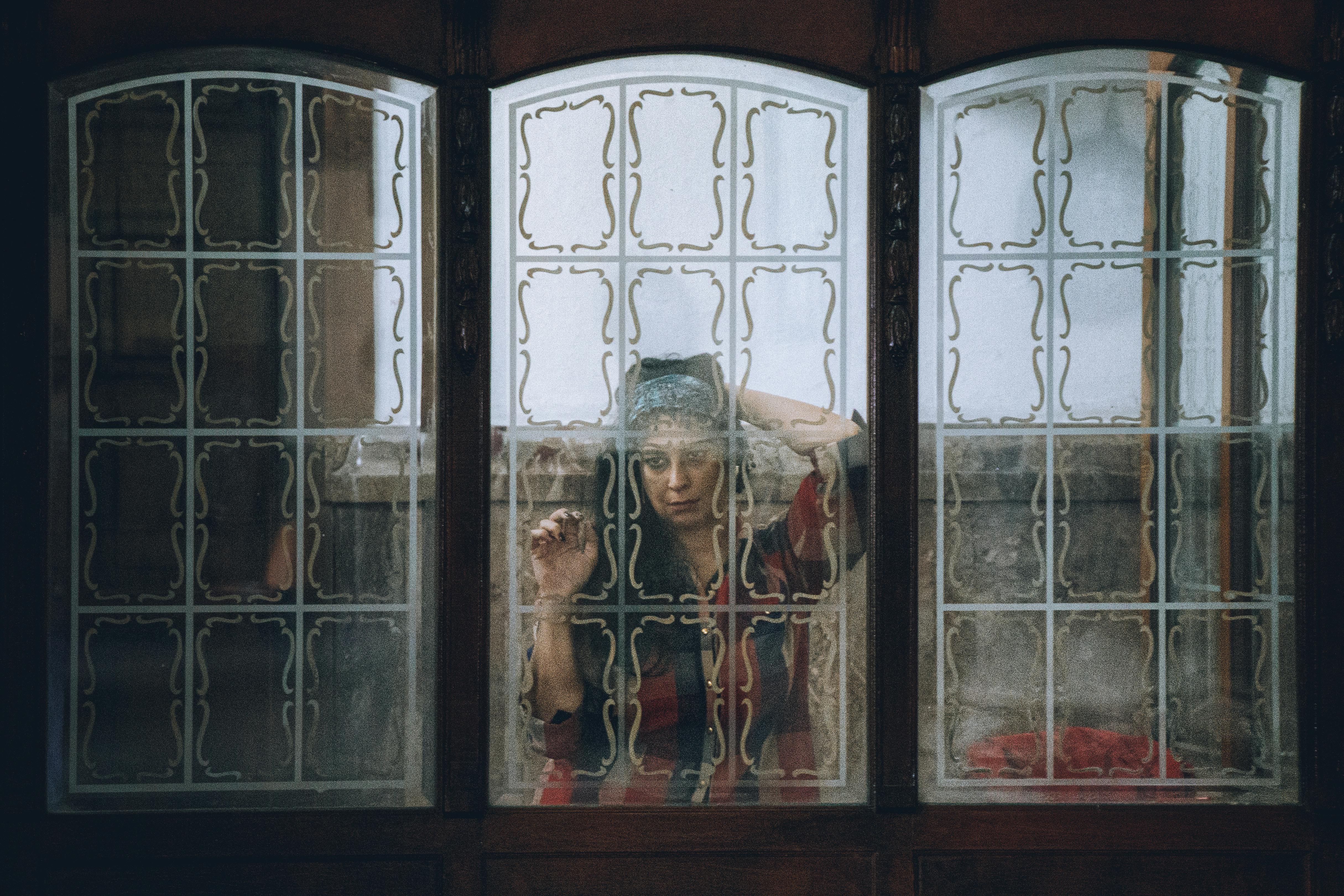 Woman Standing Behind the Window · Free Stock Photo