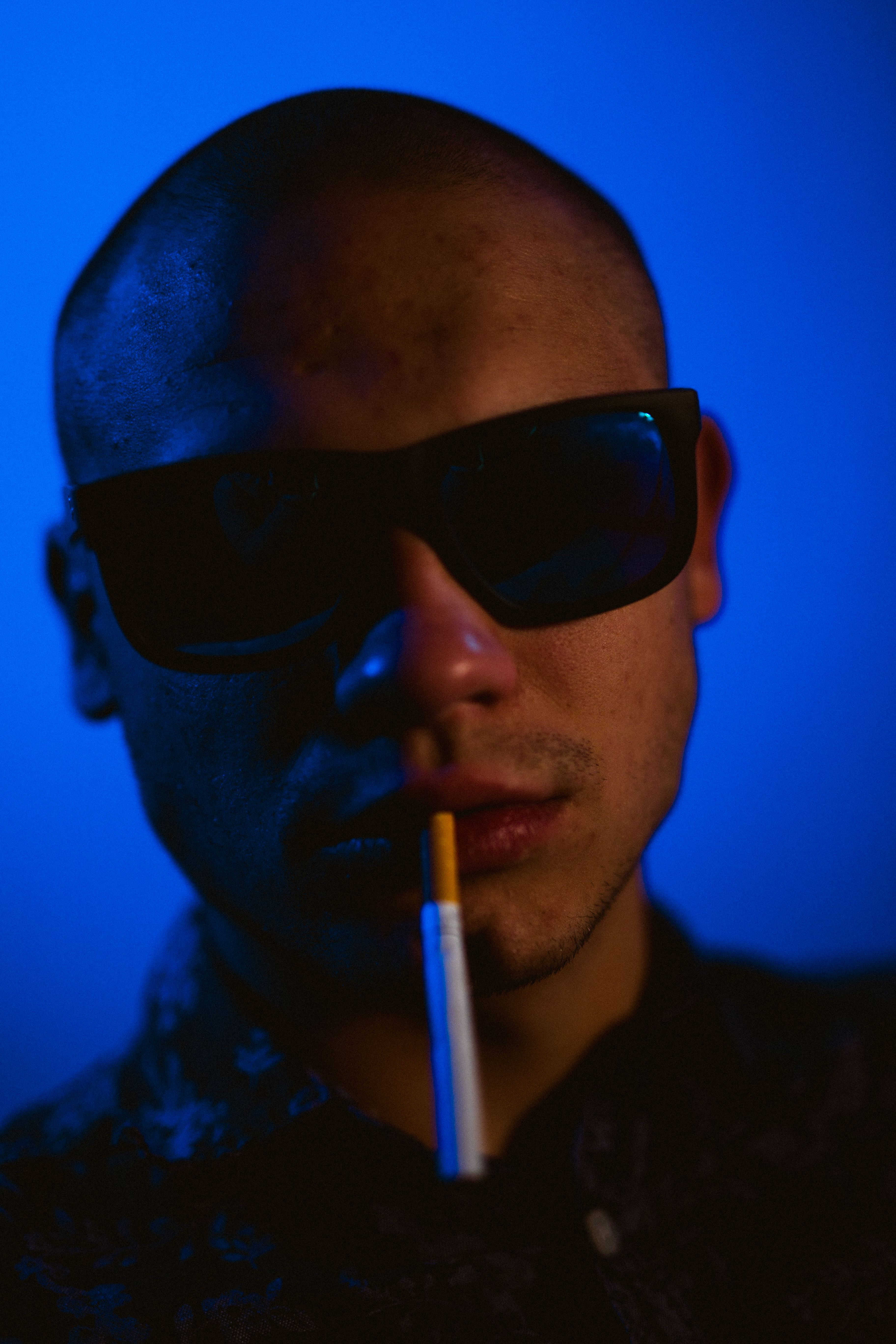 Portrait of Bald Man Smoking a Cigarette · Free Stock Photo