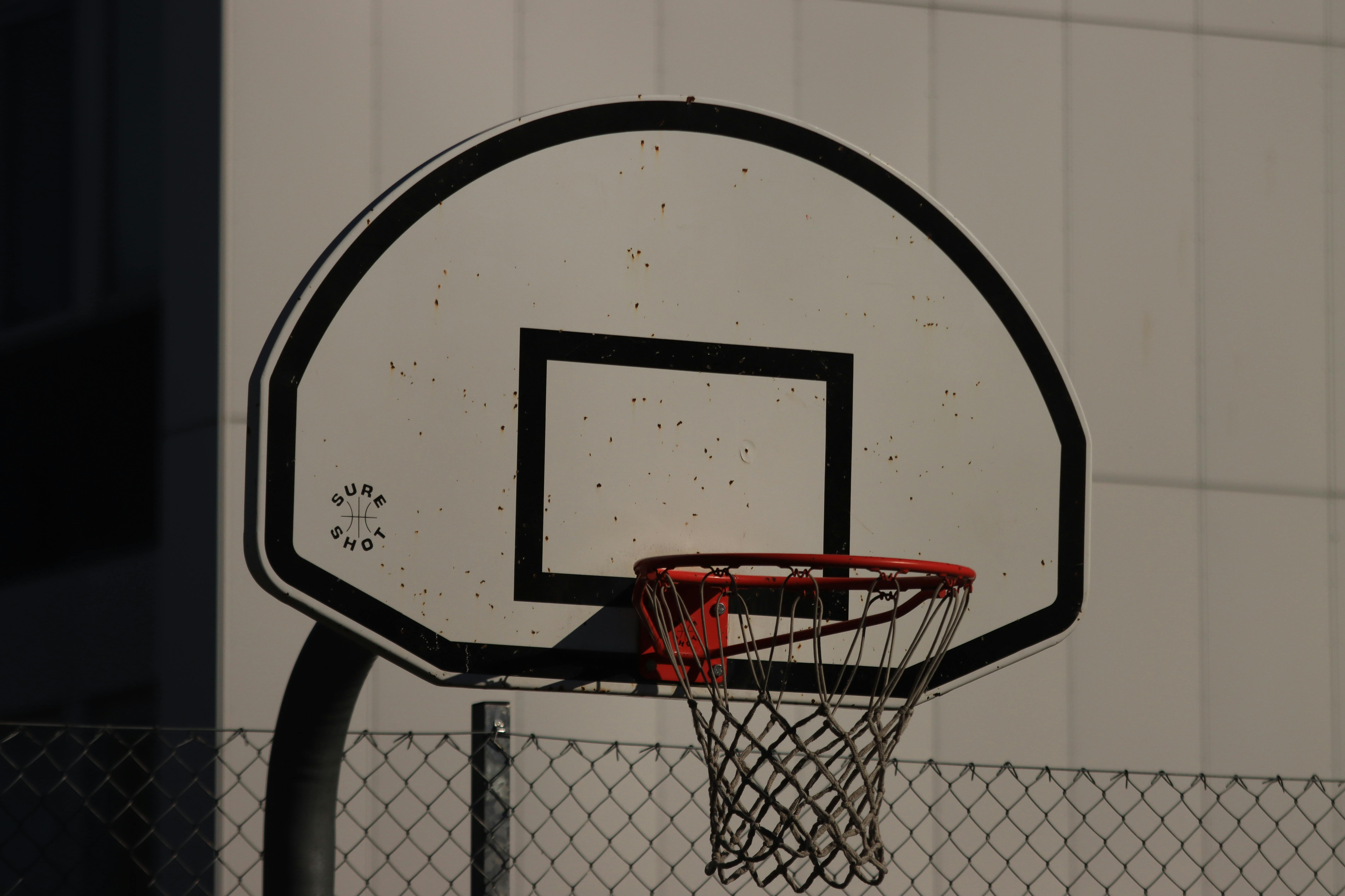 Close-Up Photo of a Ball with Basketball Hoop · Free Stock Photo