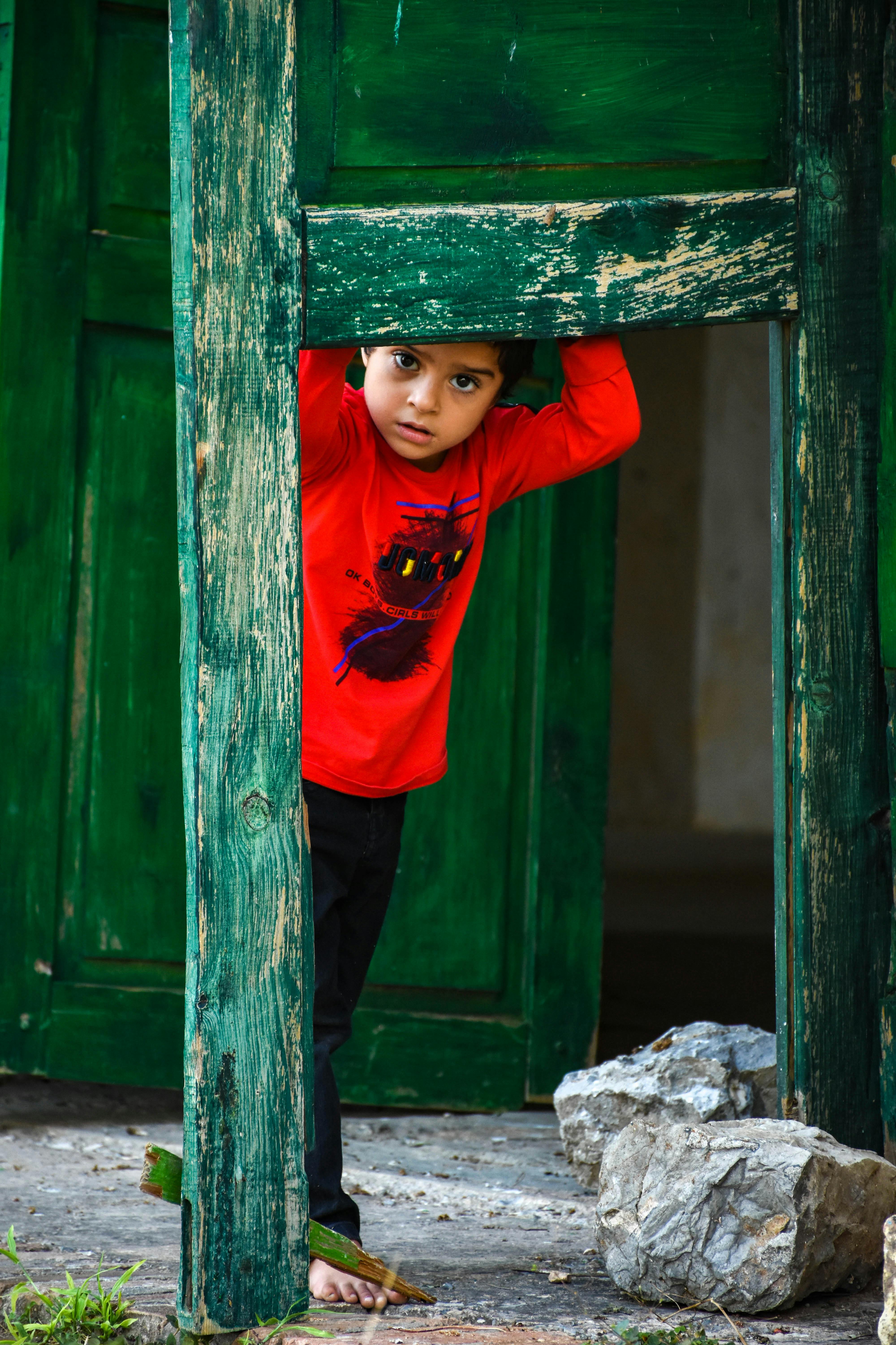 Child Leaning on a Wooden Structure · Free Stock Photo