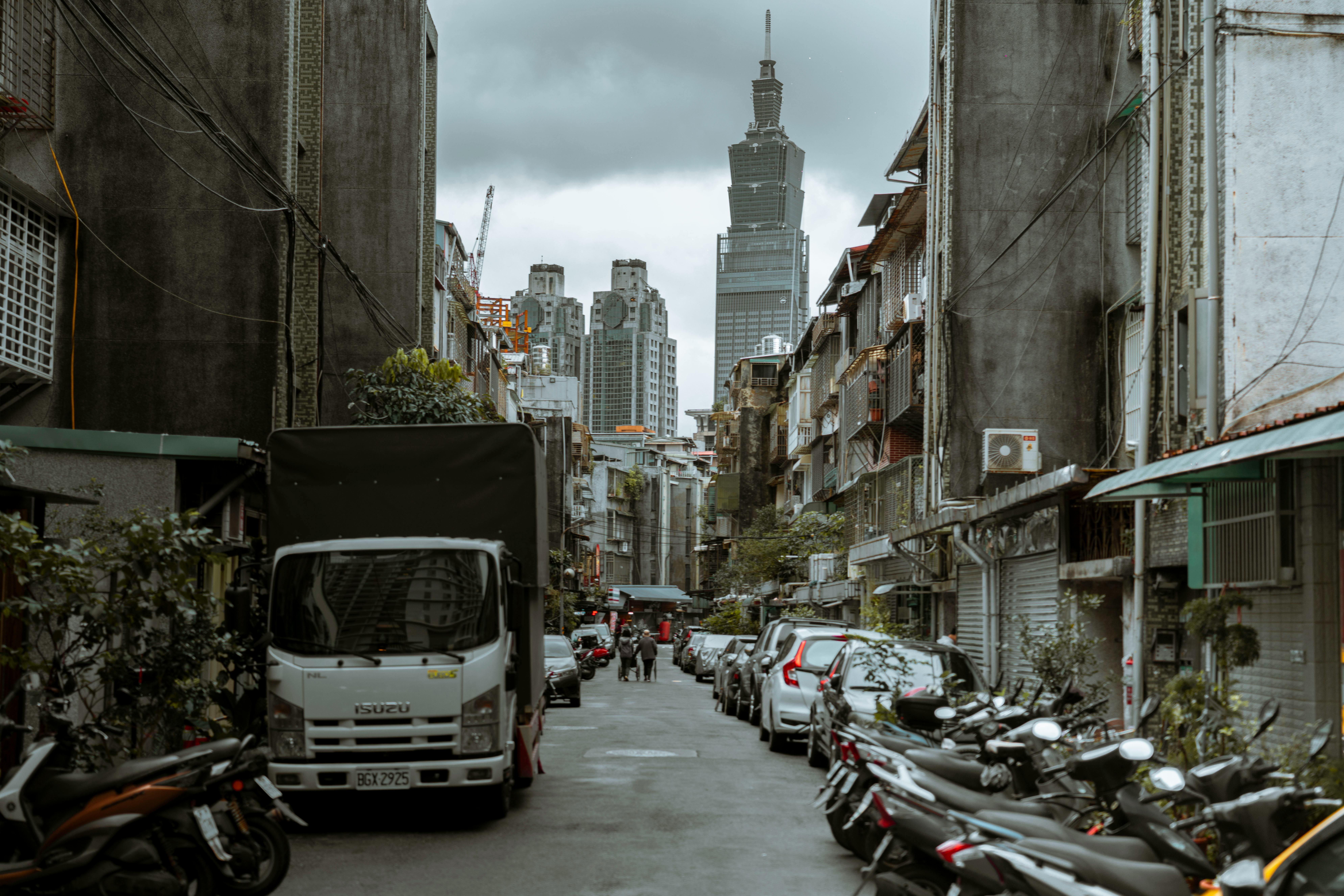 A Busy Street Filled with Vehicles Parked near the Buildings · Free ...