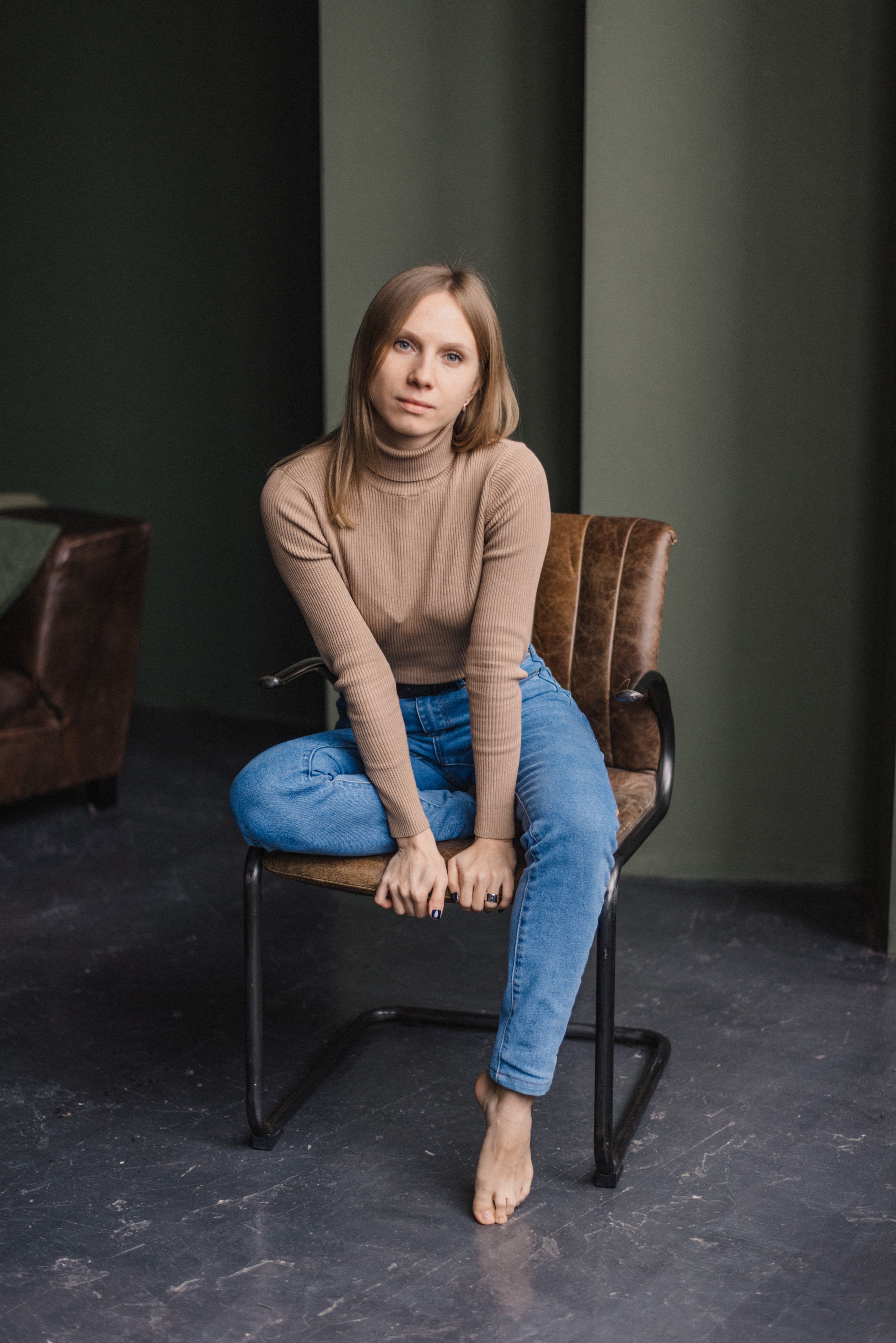 Barefoot Woman Sitting on Office Chair · Free Stock Photo
