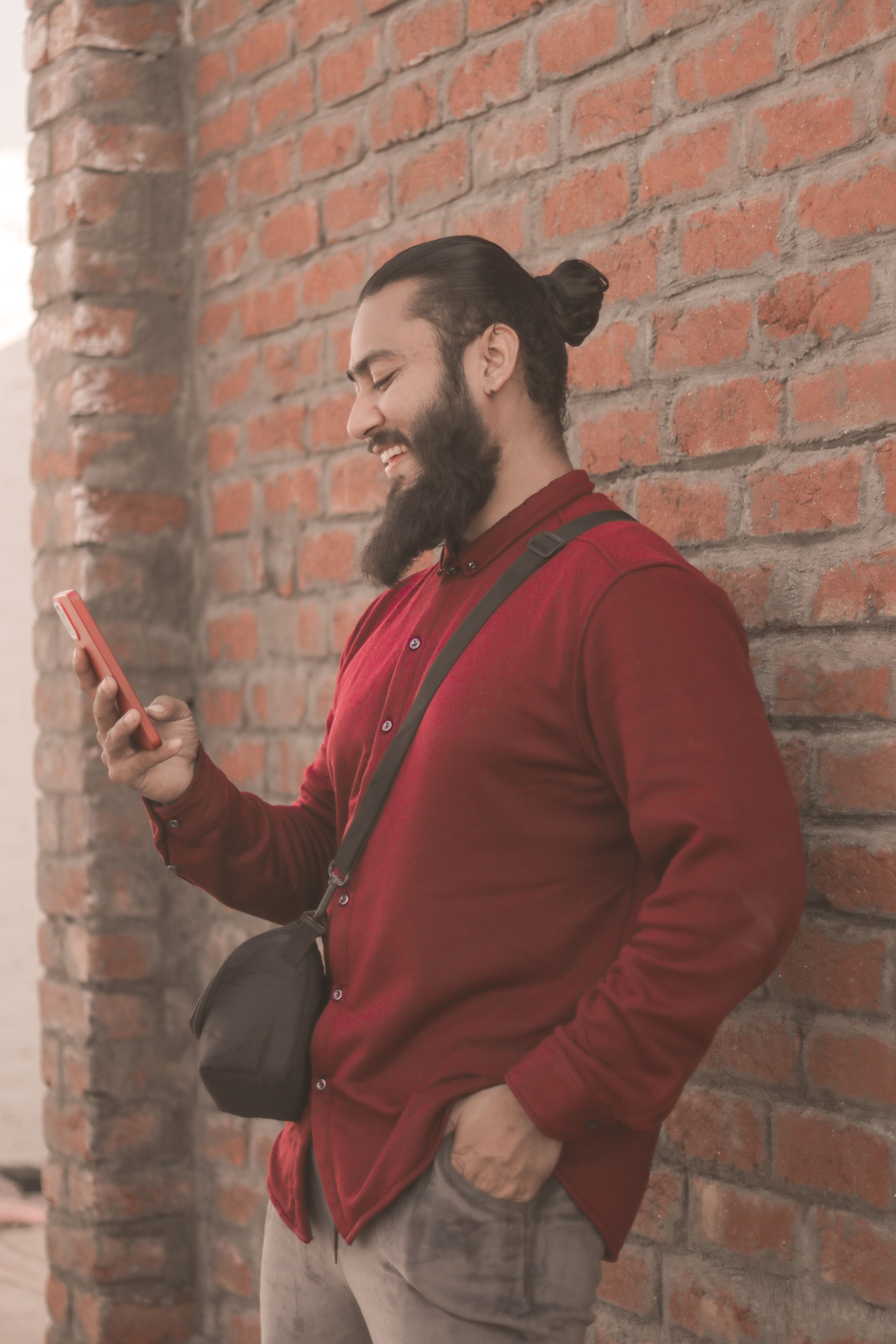 Man Leaning against Table Using Phone · Free Stock Photo