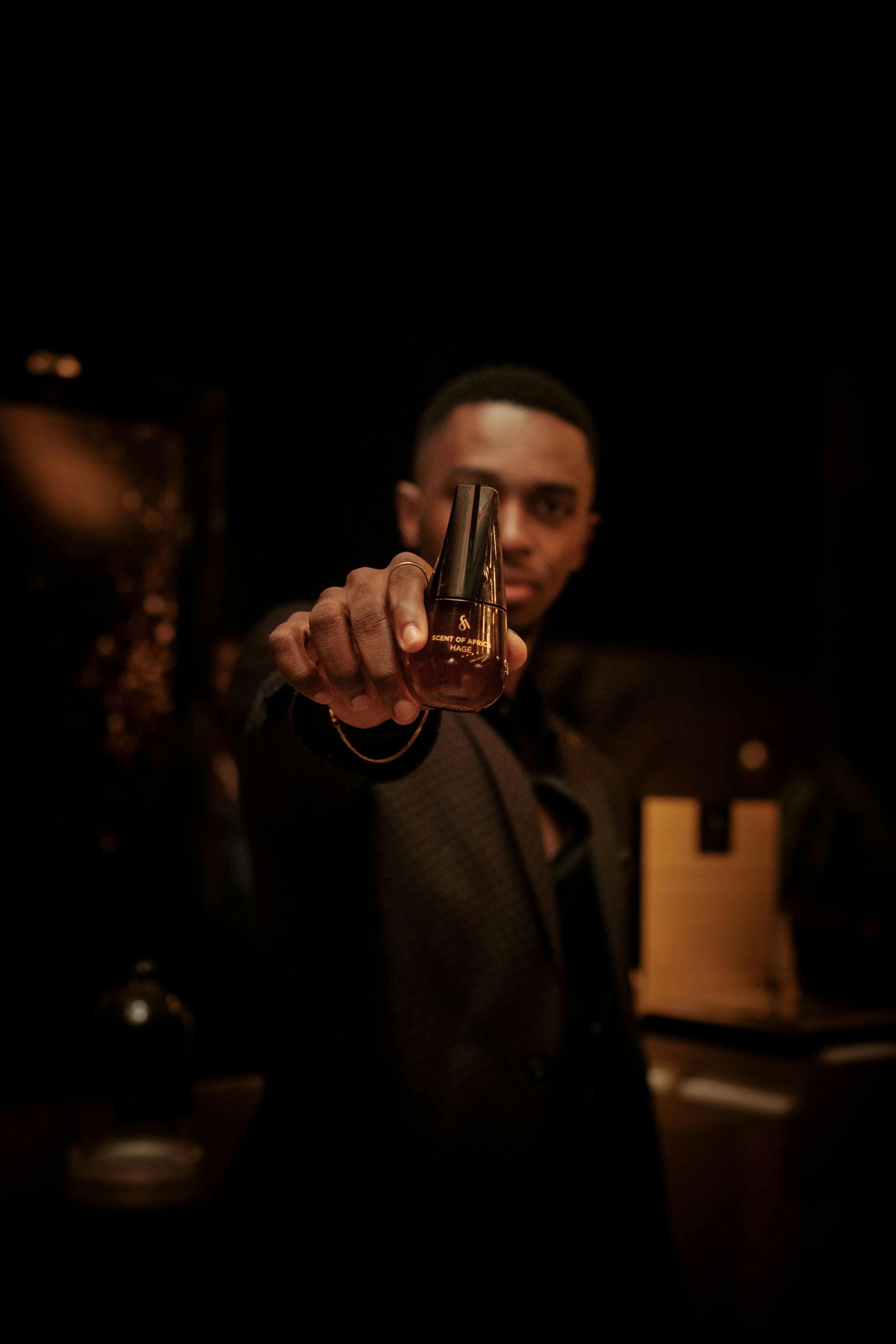 Elegant Man Showing Perfumes · Free Stock Photo