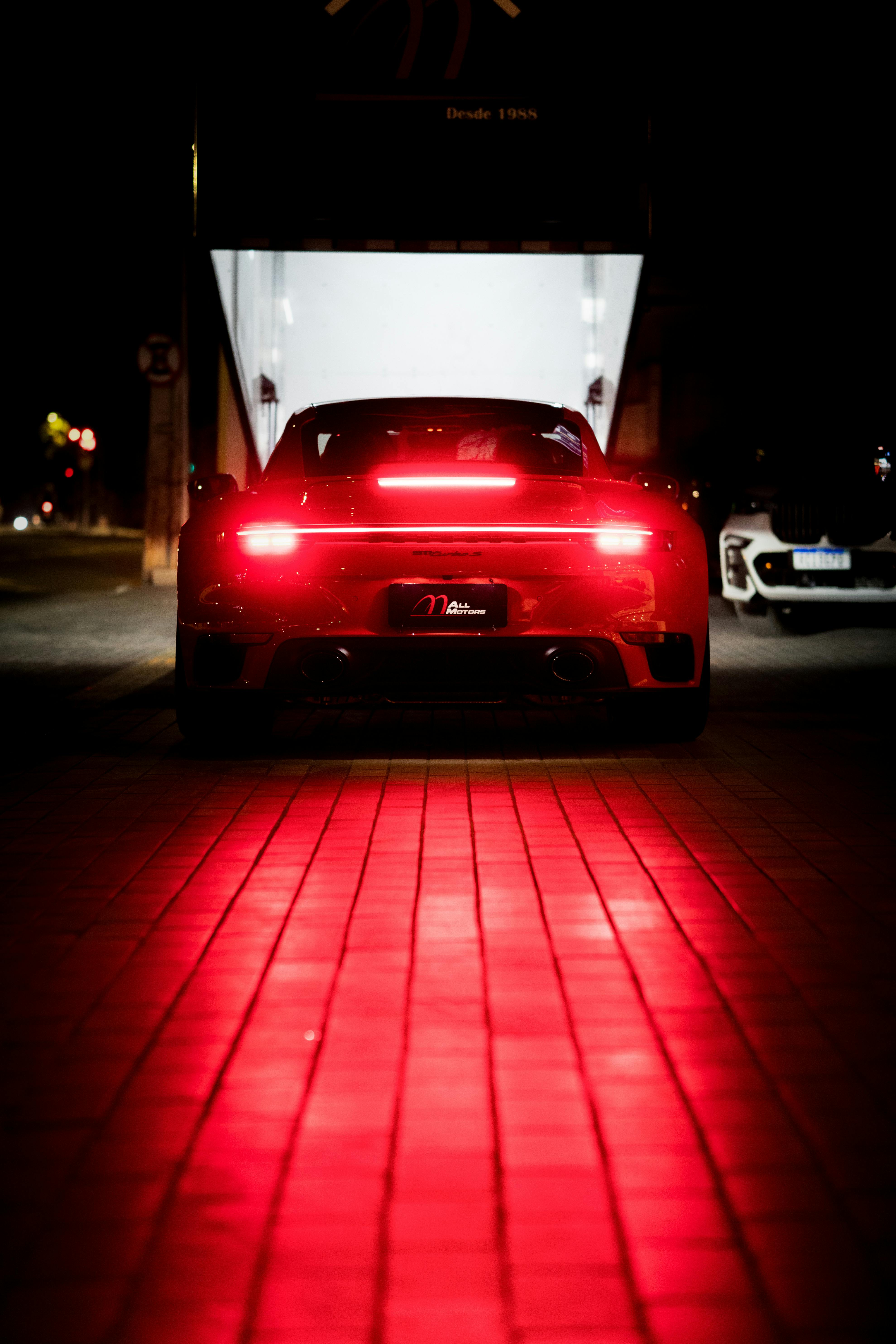 A Car with Red LED Tail Lights on a Brick Floor · Free Stock Photo