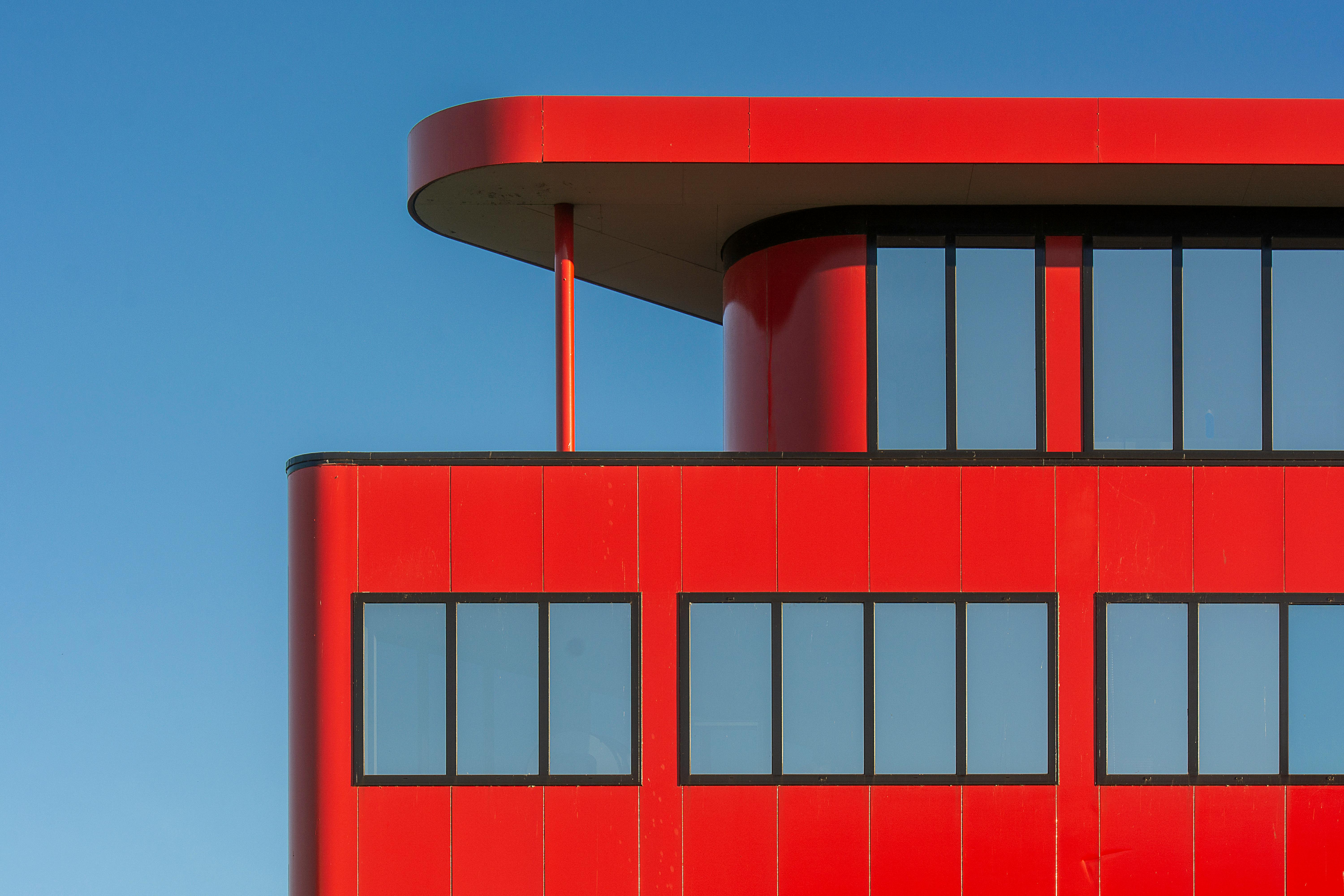 A Red Building Under the Clear Blue Sky · Free Stock Photo