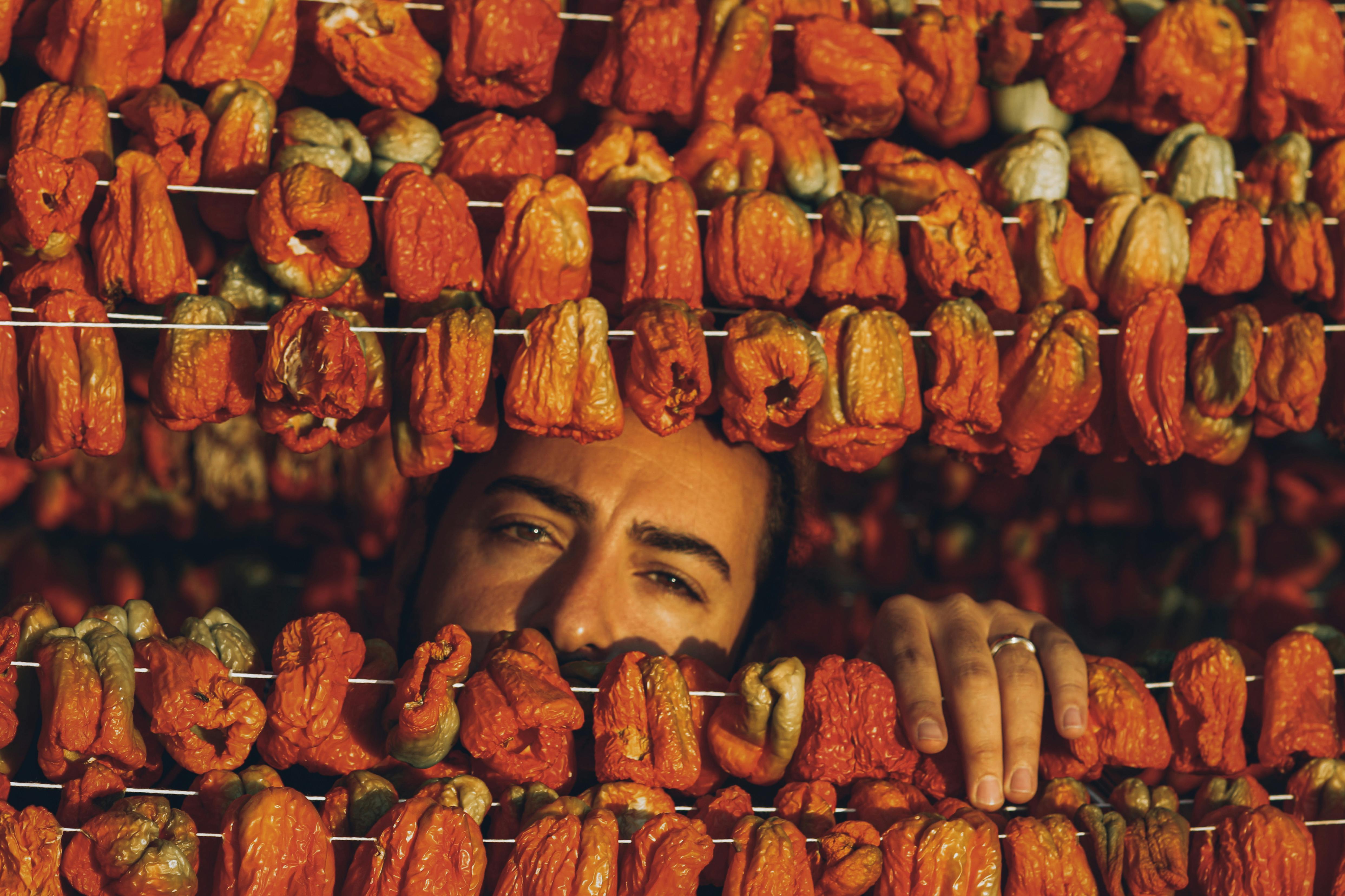 Face among Dry Peppers · Free Stock Photo