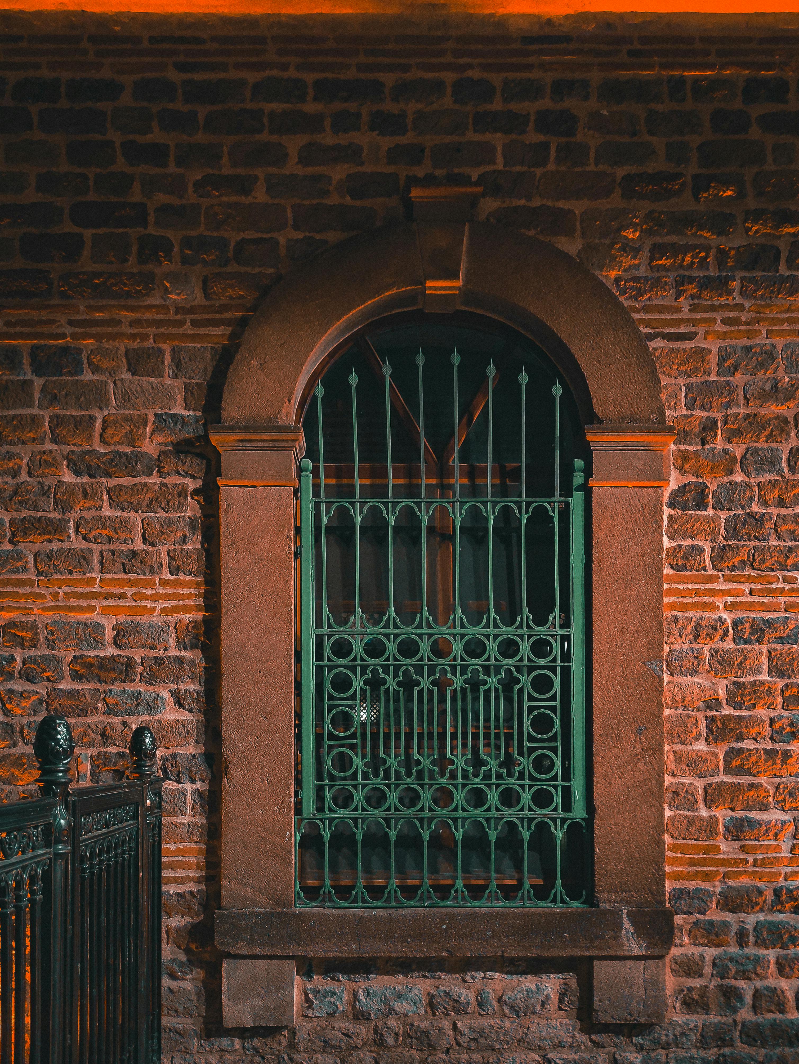 Green Metal Grills on the Window of Red Brick Wall · Free Stock Photo