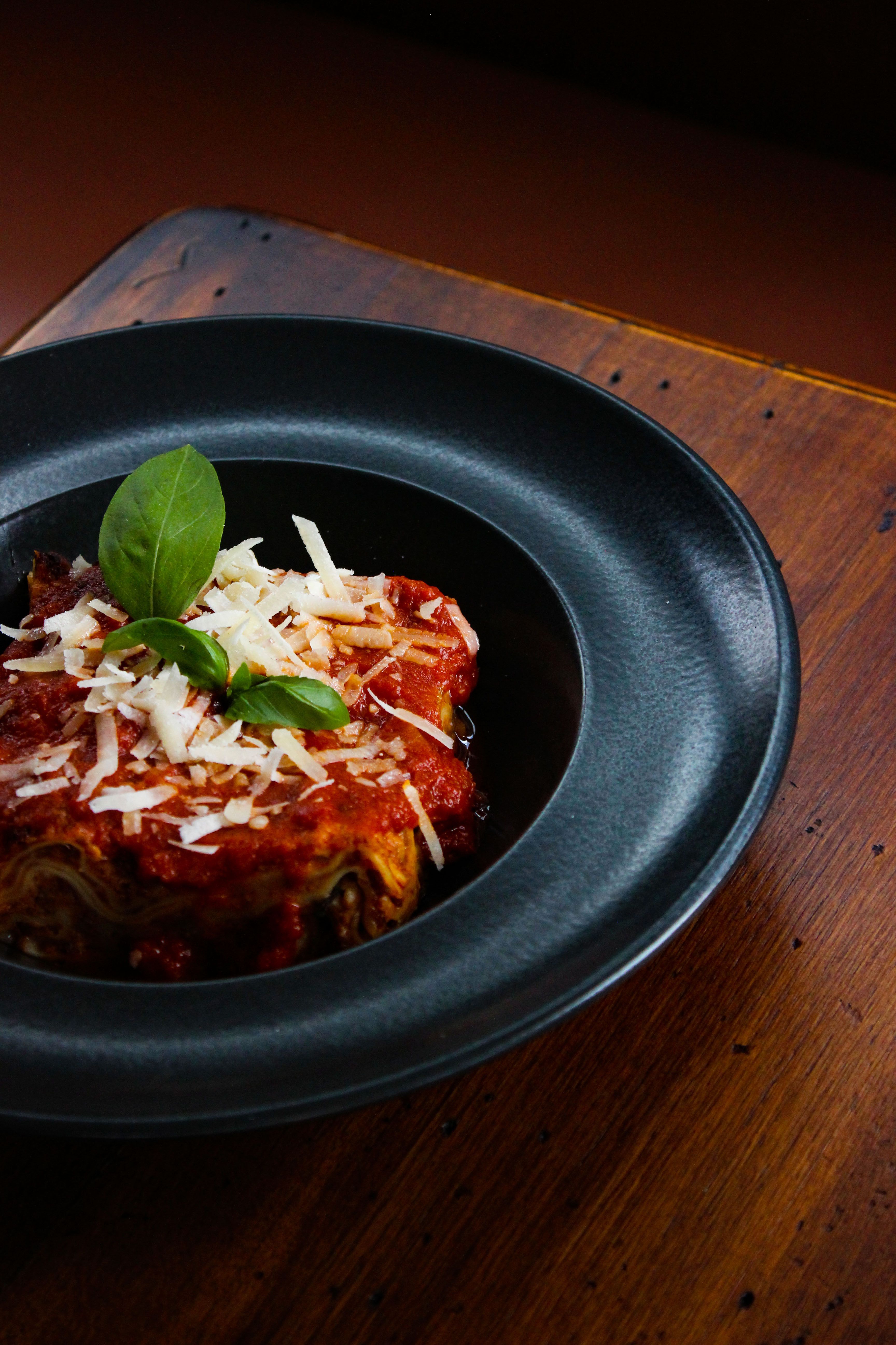 Mouthwatering Lasagna on Black Ceramic Plate · Free Stock Photo
