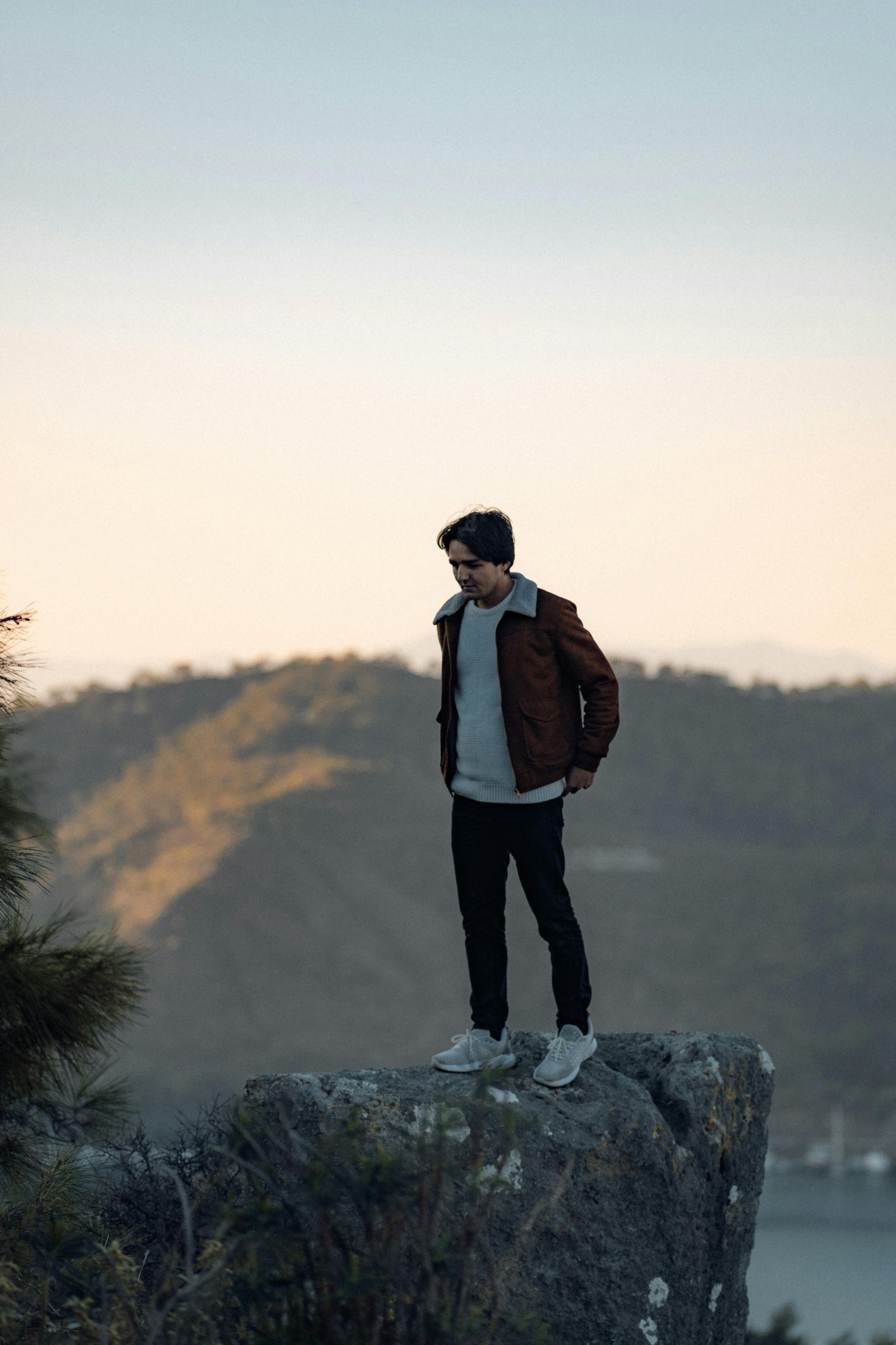 Man Standing on a Cliff Overlooking the Roads · Free Stock Photo
