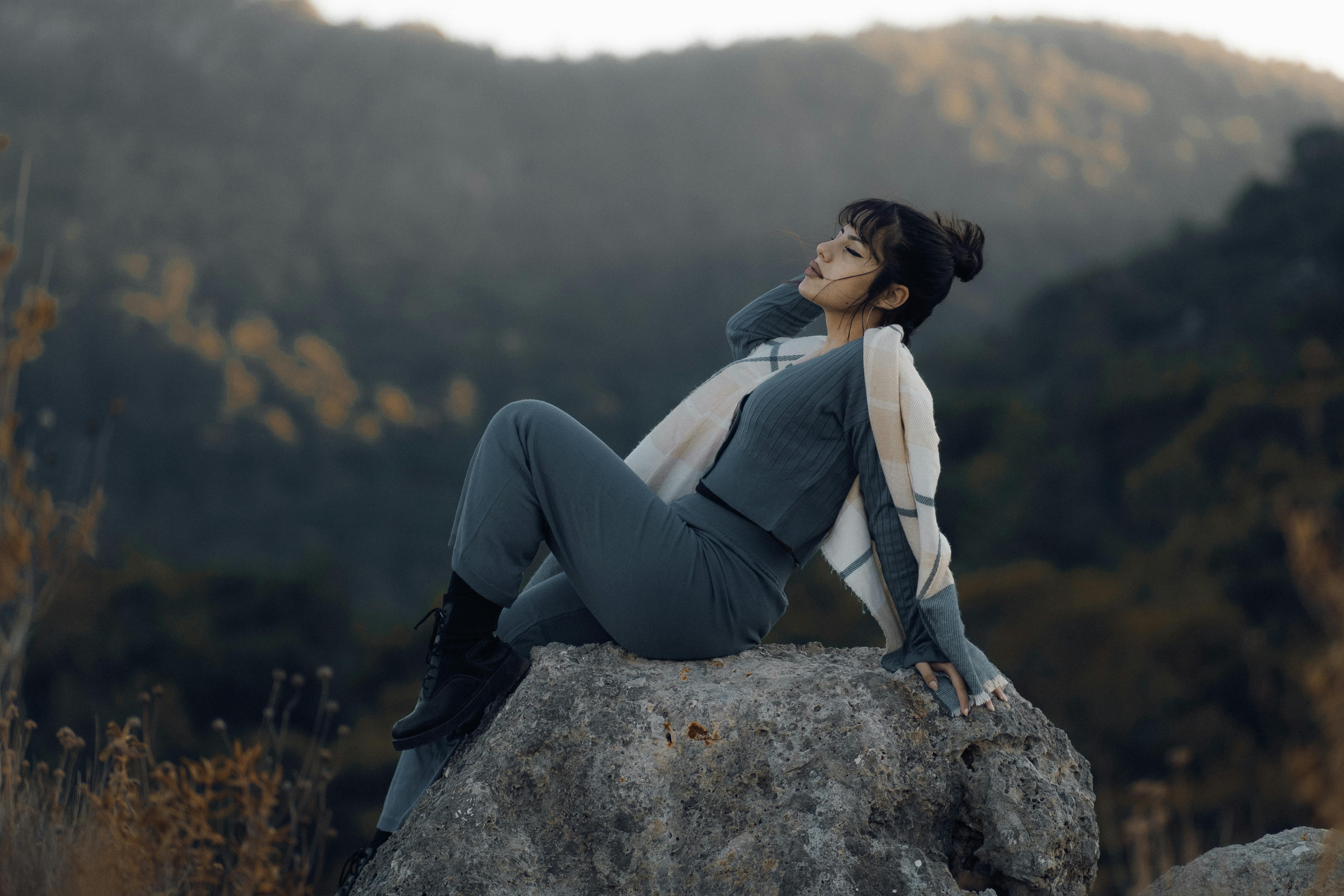Person Sitting on Rock · Free Stock Photo