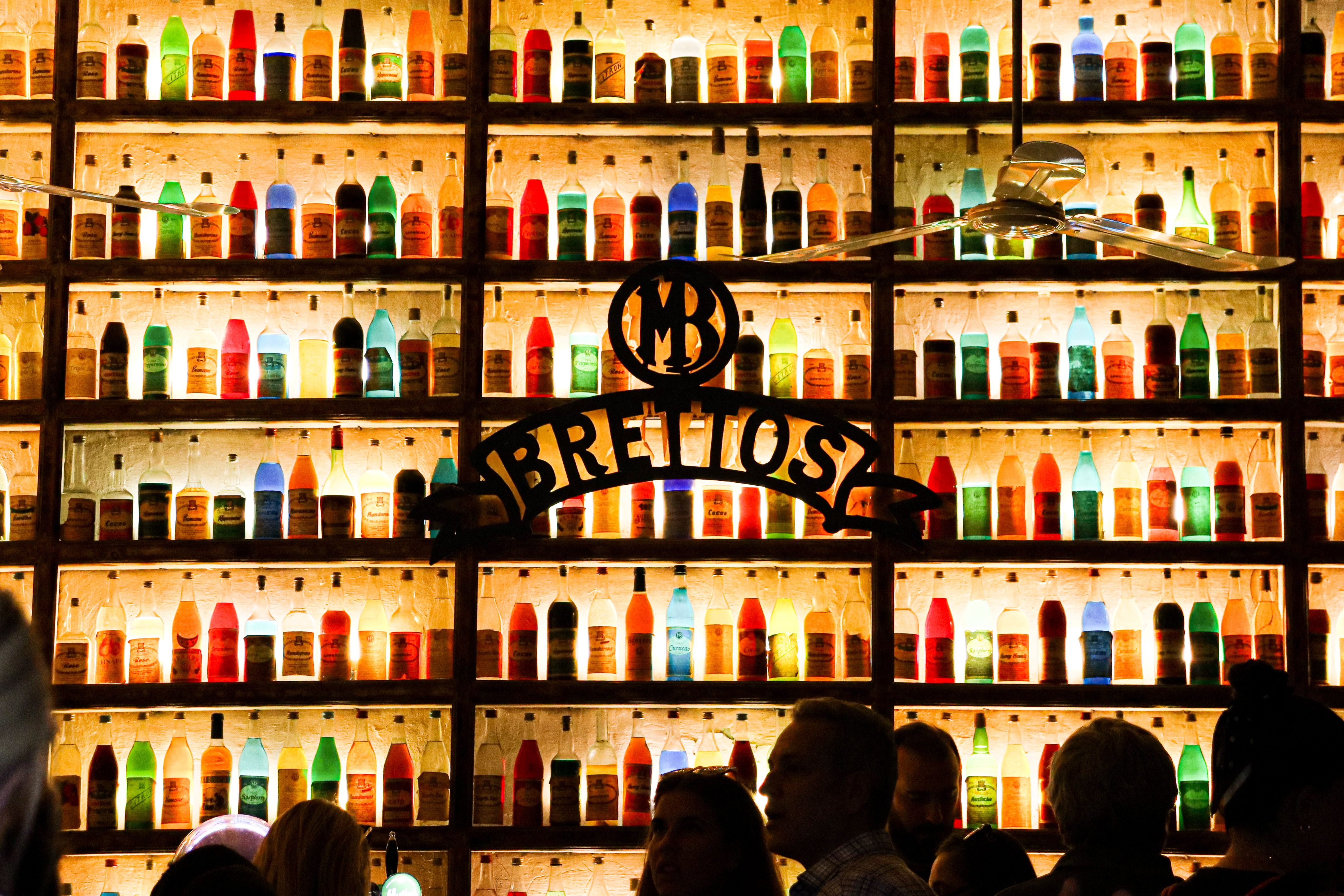 Illuminated Shelves with Bottles of Alcohol in Bar · Free Stock Photo
