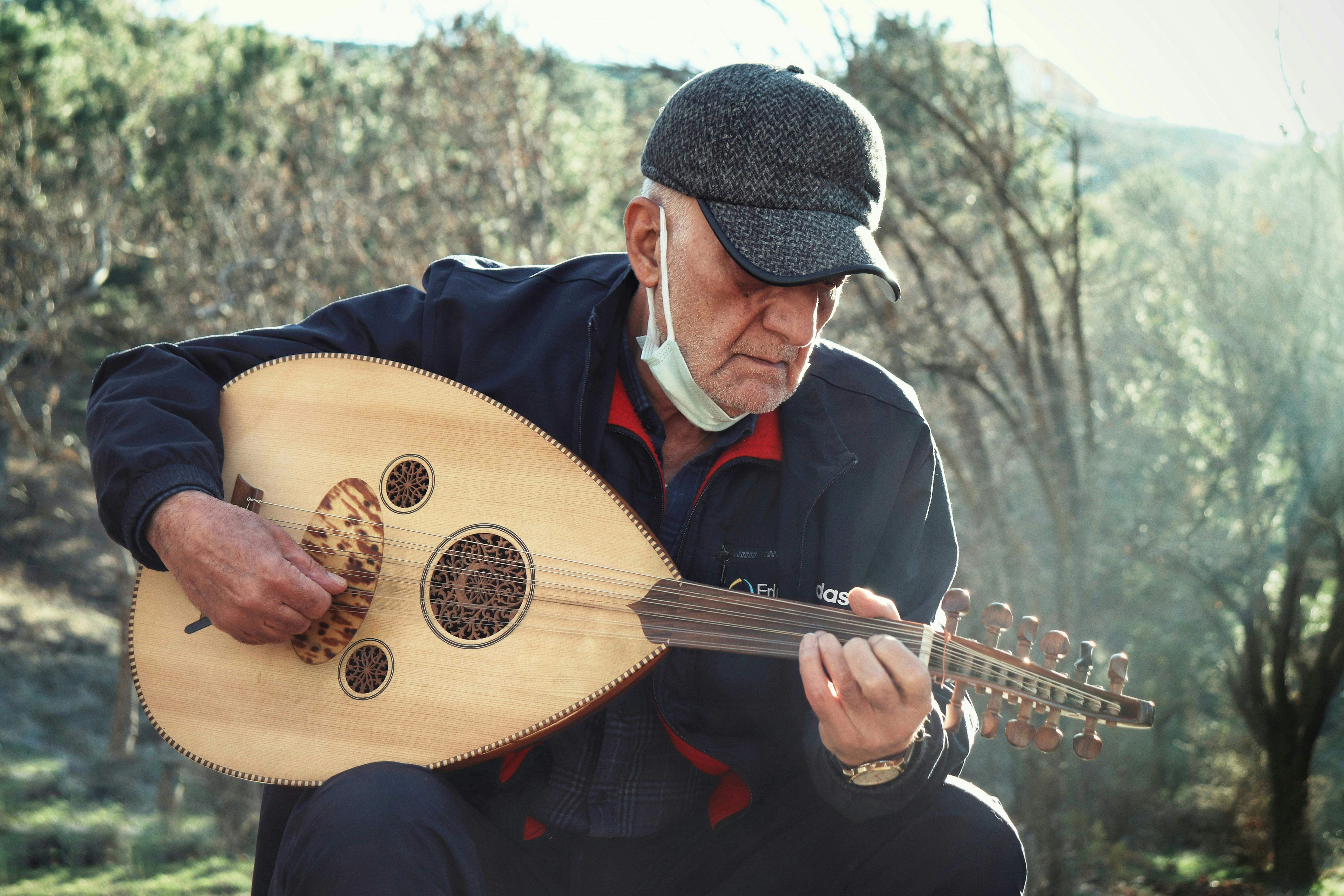 An Elderly Man Playing Oud · Free Stock Photo