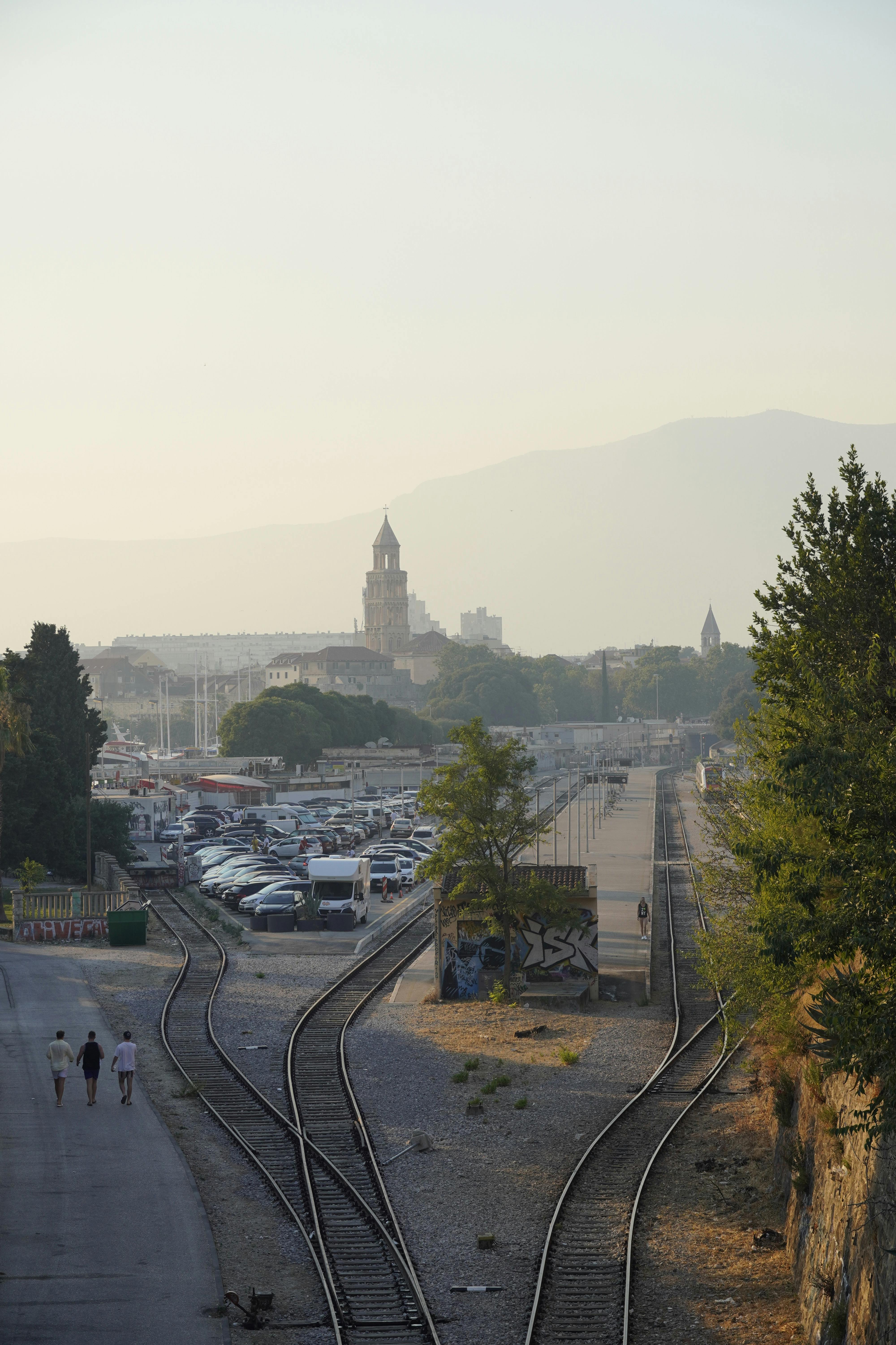 Railway Tracks Separating before City · Free Stock Photo
