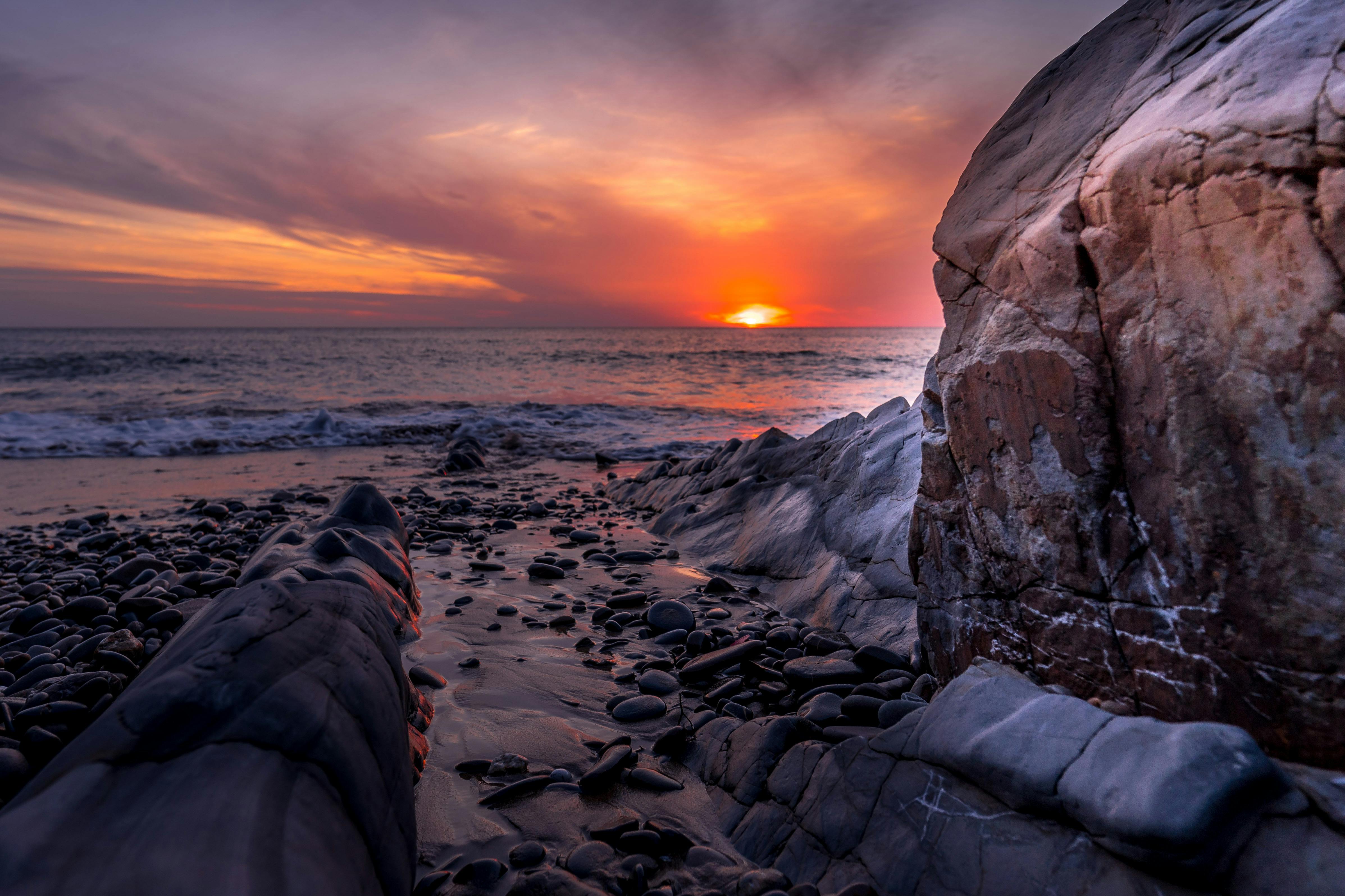 Rocks on Beach at Sunset · Free Stock Photo