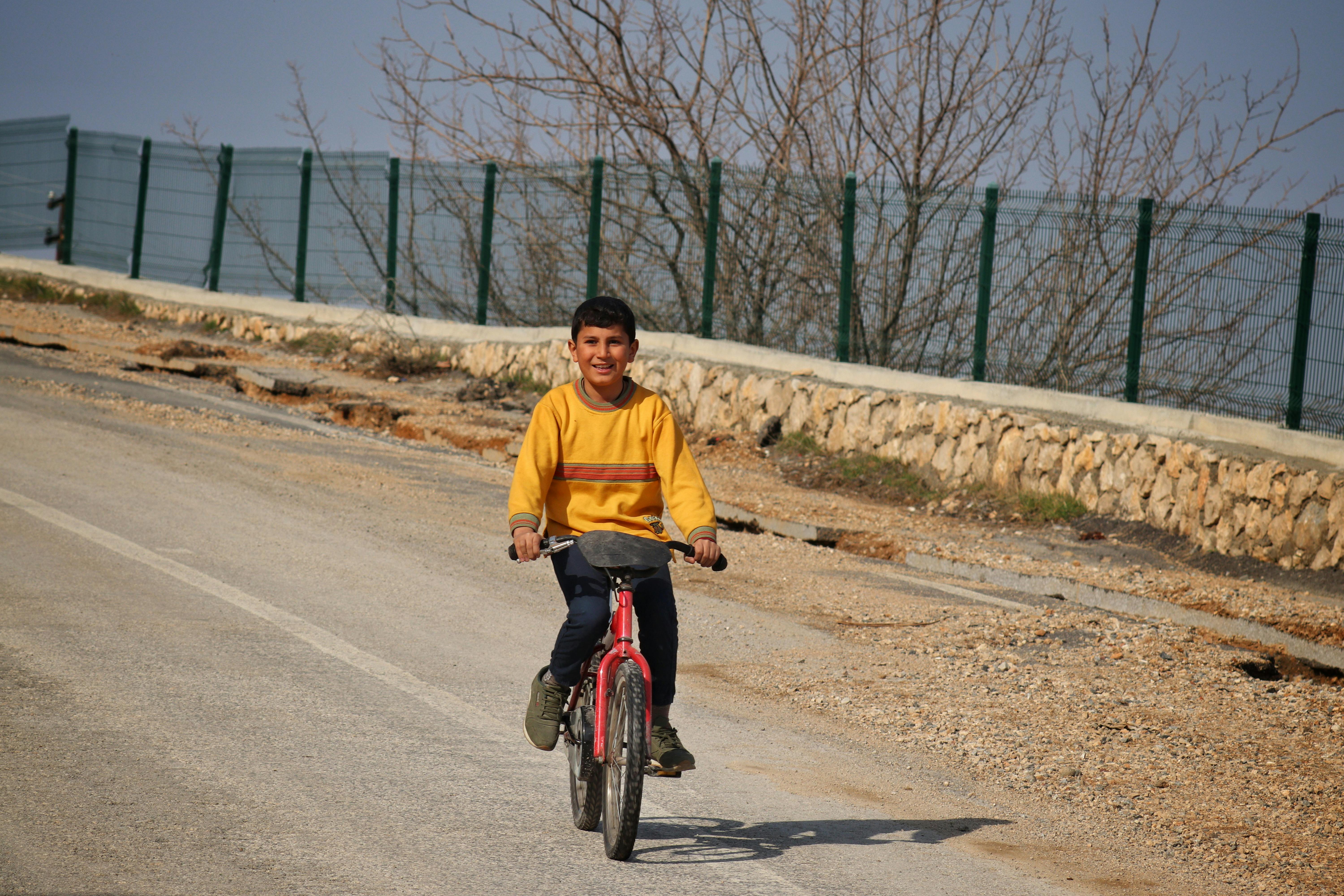 A Young Boy Riding a Bicycle · Free Stock Photo