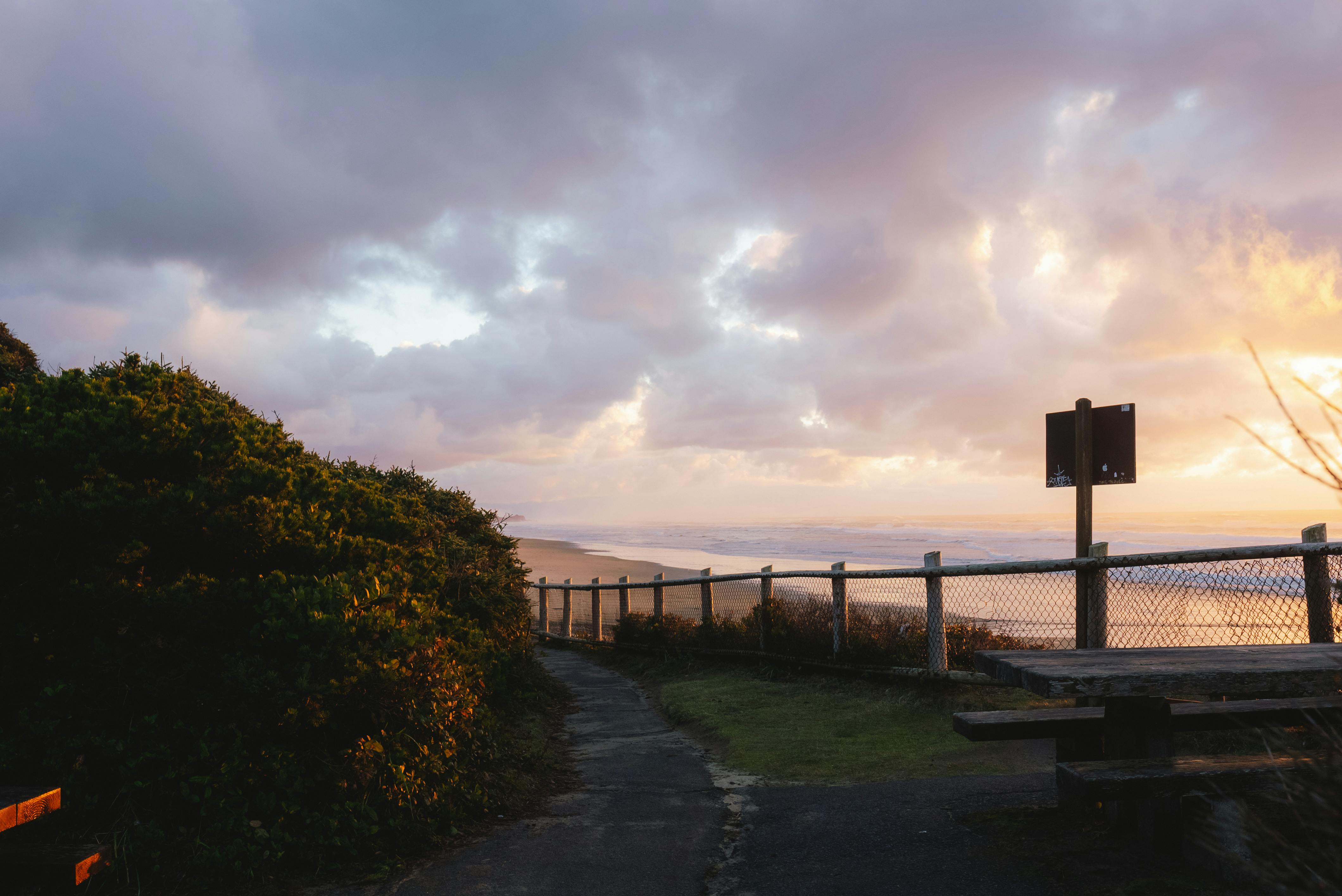Paved Pathway Near Chain Link Fence · Free Stock Photo