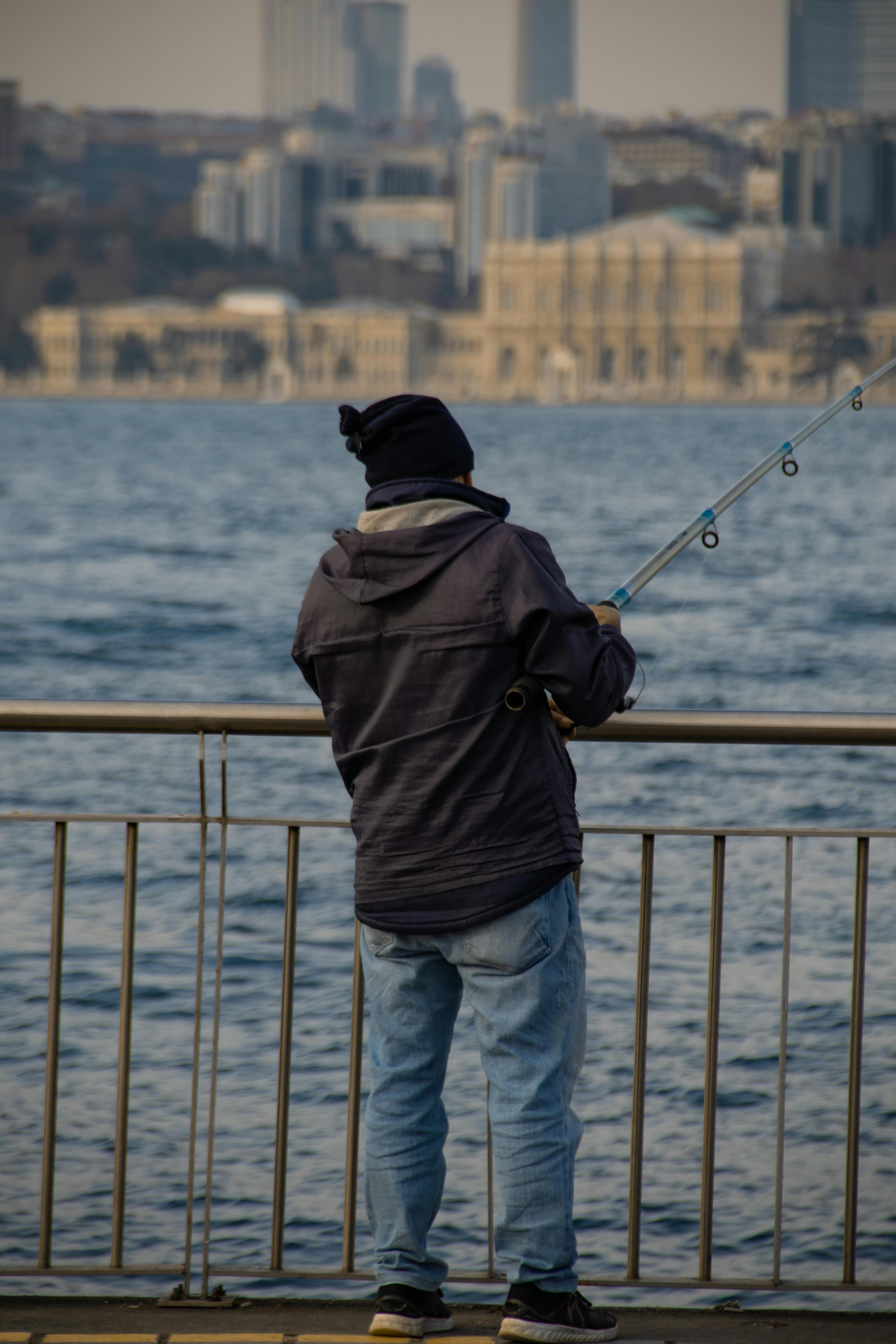 Man Fishing from Bridge · Free Stock Photo