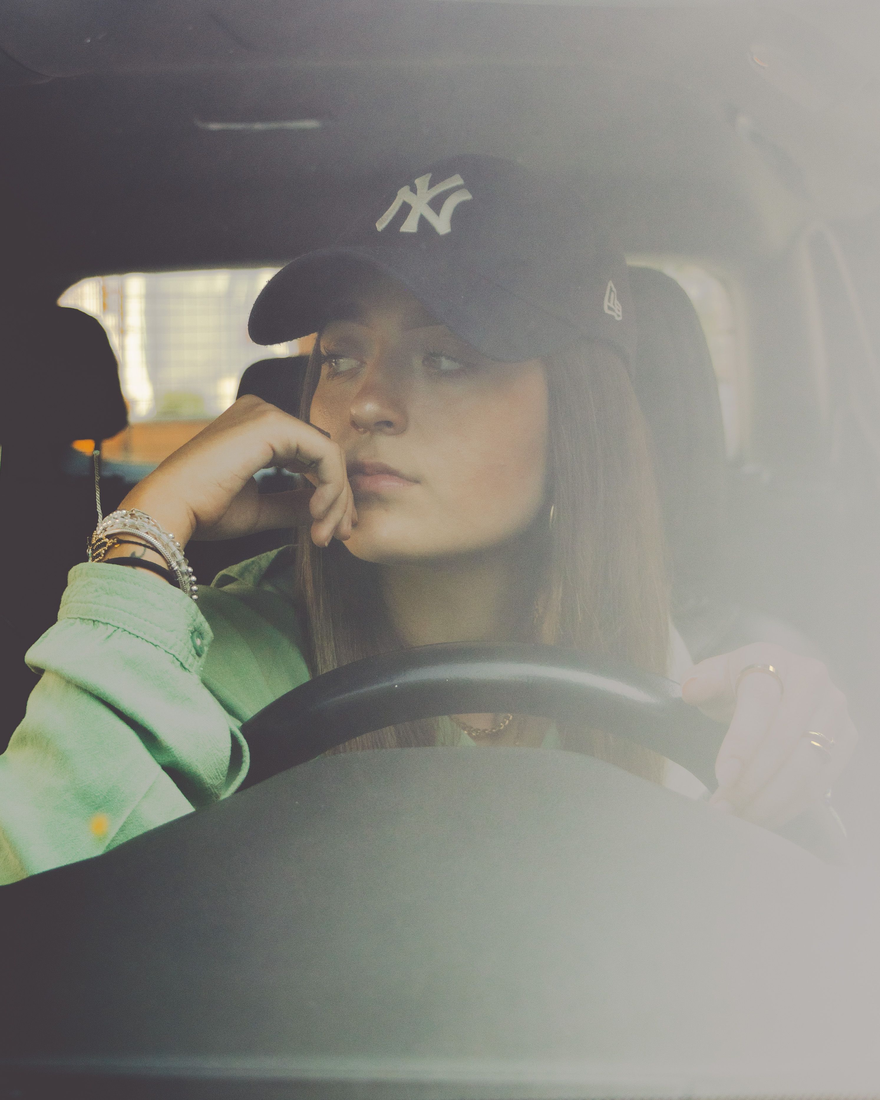Portrait of a Woman with a Cap Looking Sideways · Free Stock Photo