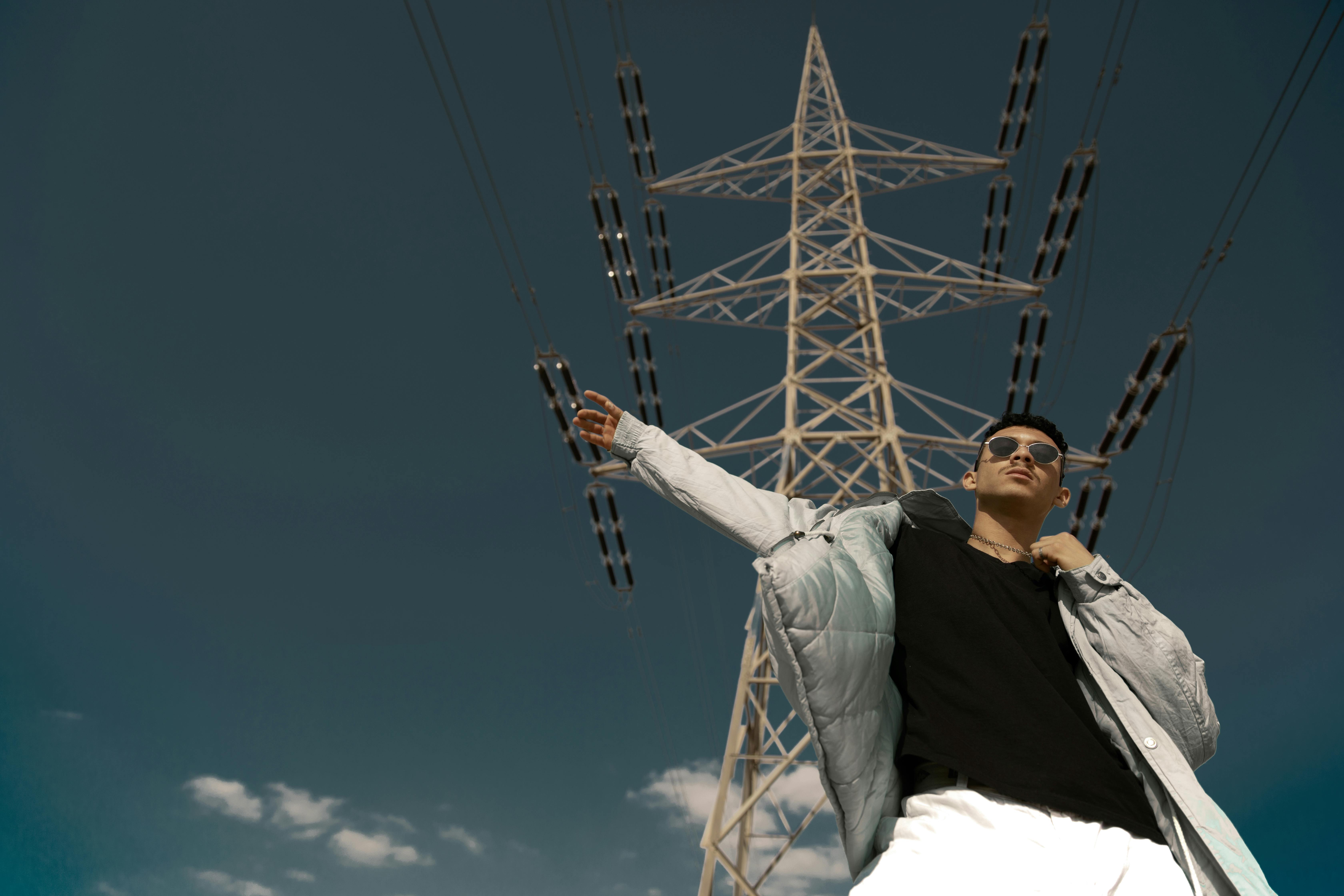 A man standing on top of a power pole · Free Stock Photo