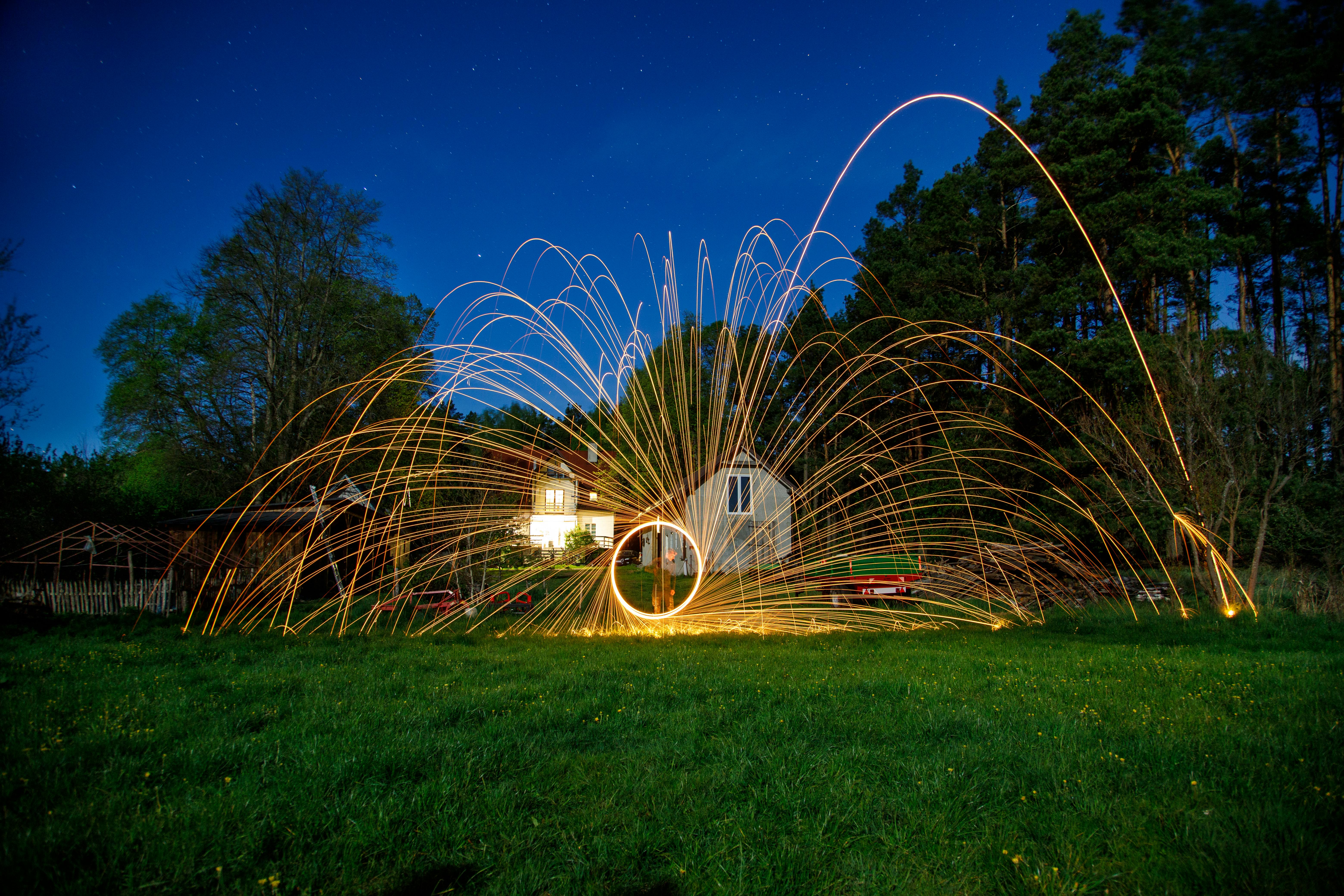 Spinning Fireworks over Green Grass · Free Stock Photo