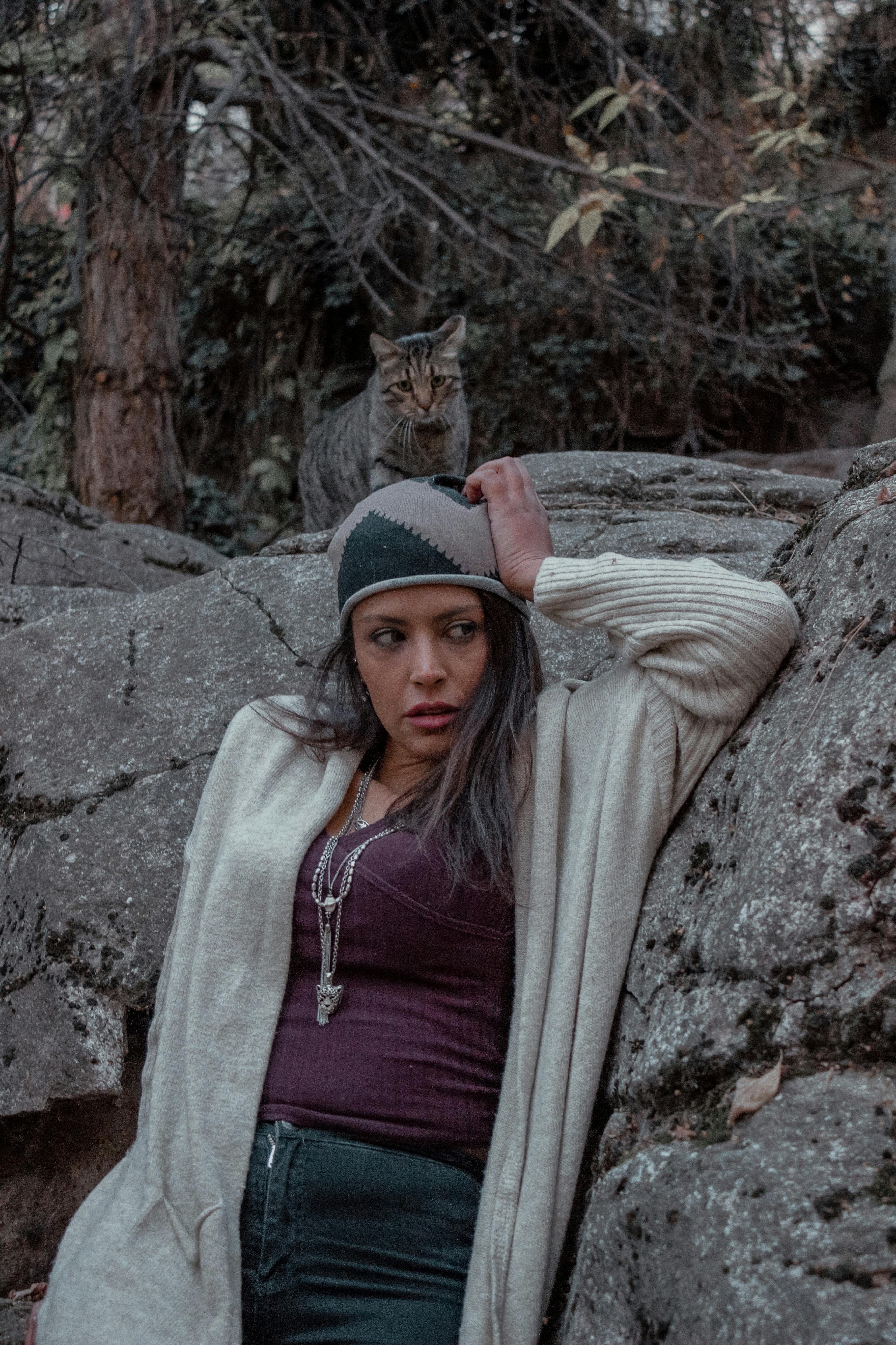 Woman Leaning against a Rock Wall · Free Stock Photo
