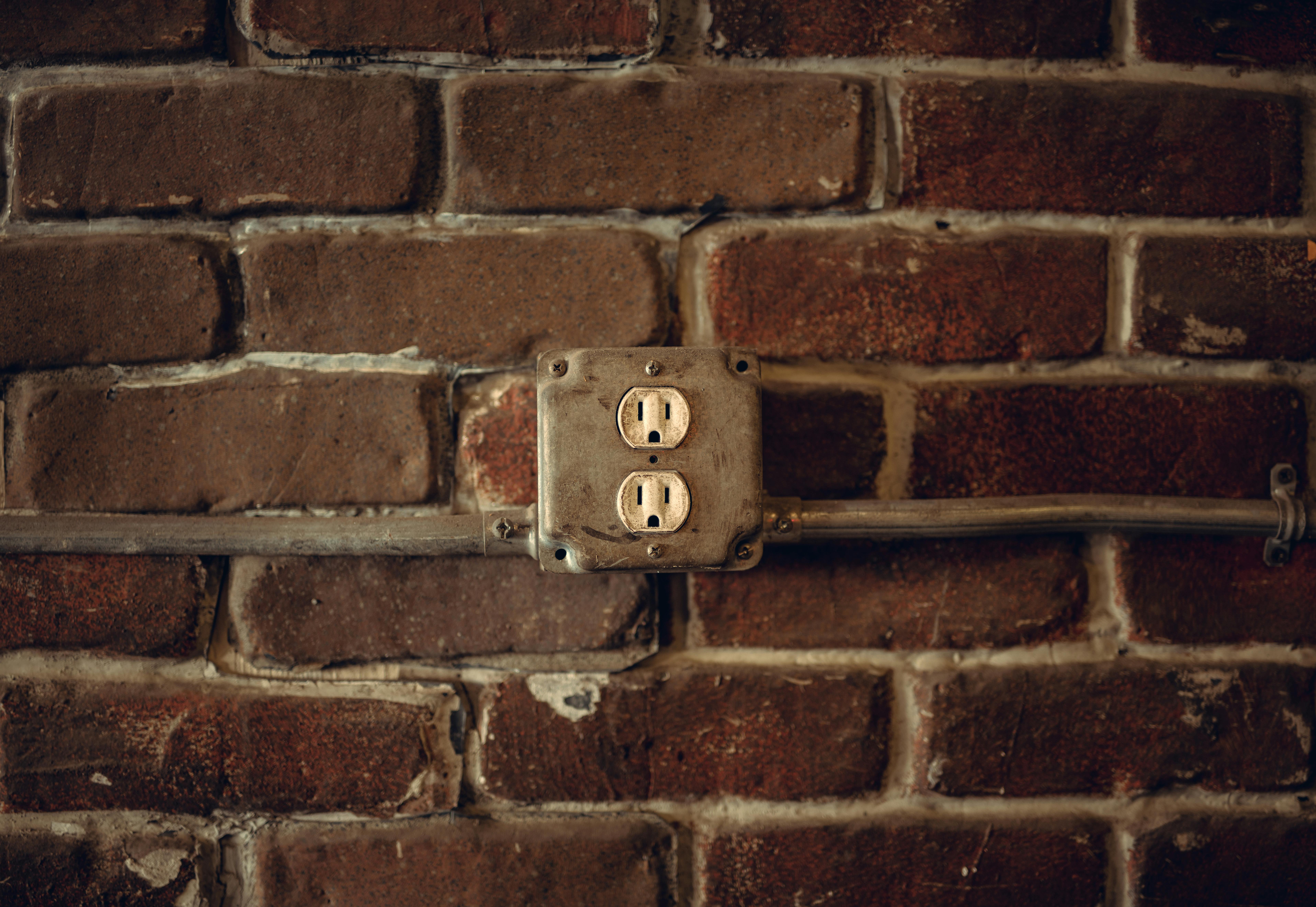A Double Gang Socket on Brown Brick Wall · Free Stock Photo