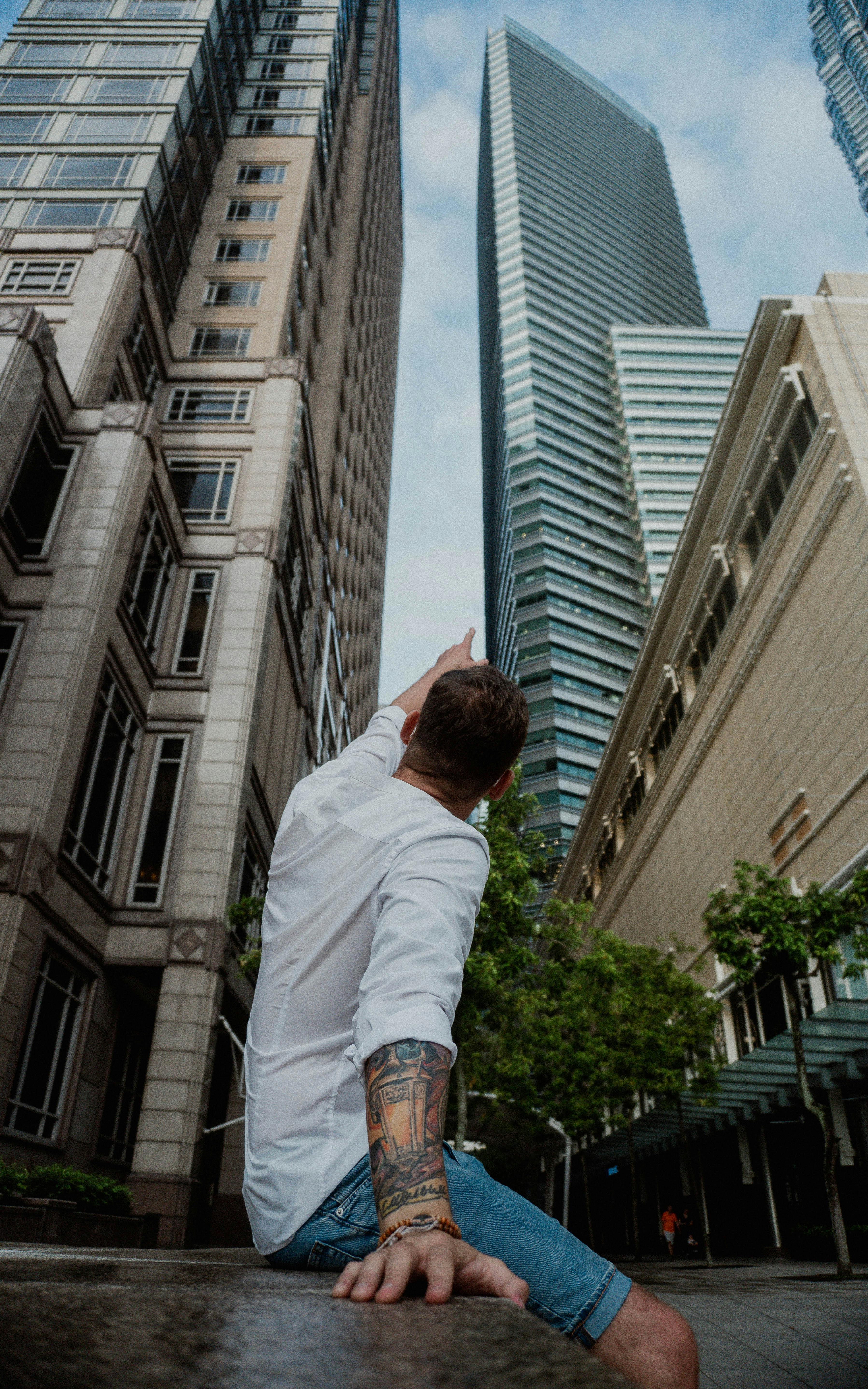 Man in White Dress Shirt Pointing Finger on a Tall Building · Free ...