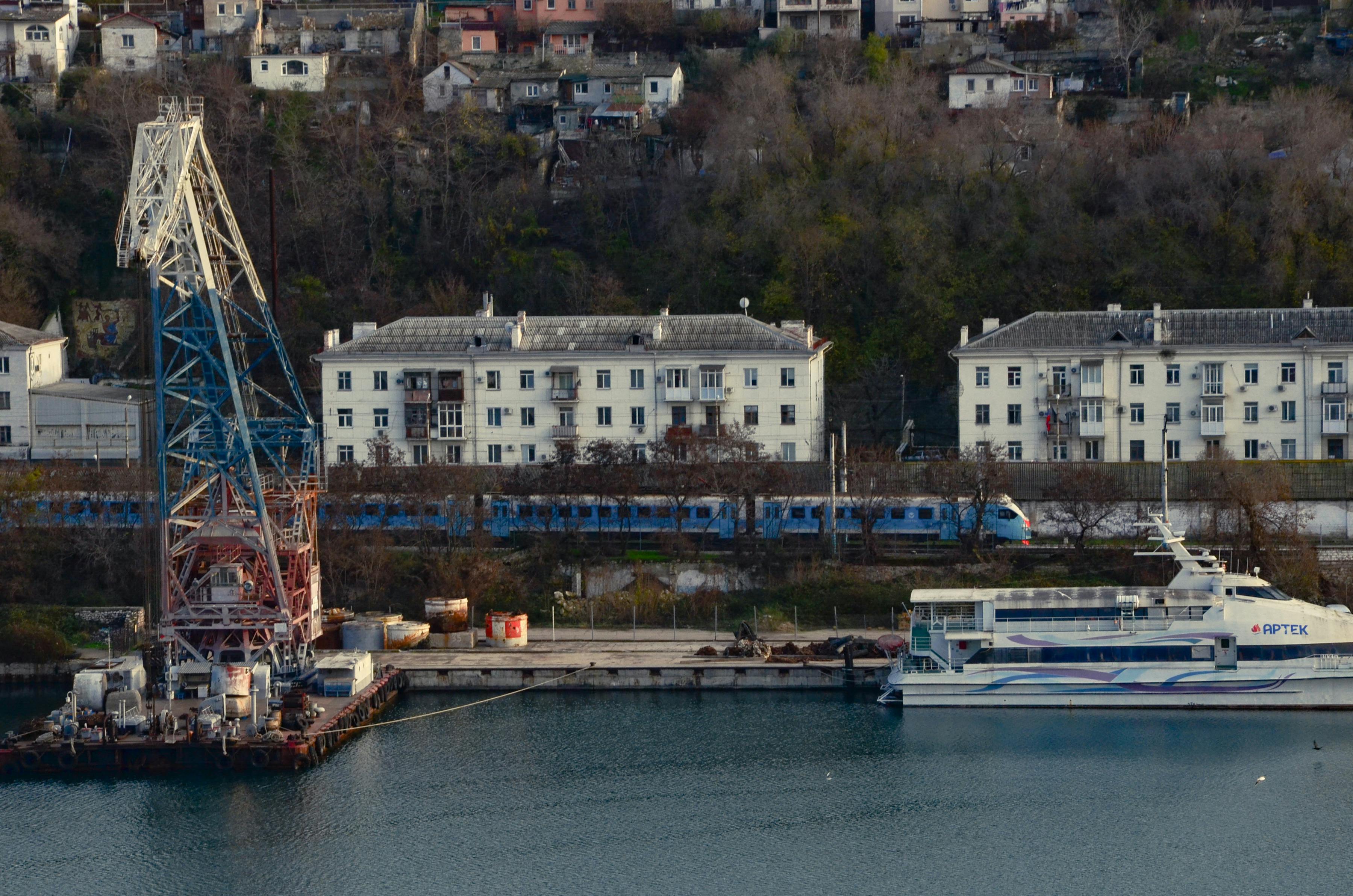 Train Riding along the Shore near a Harbor · Free Stock Photo