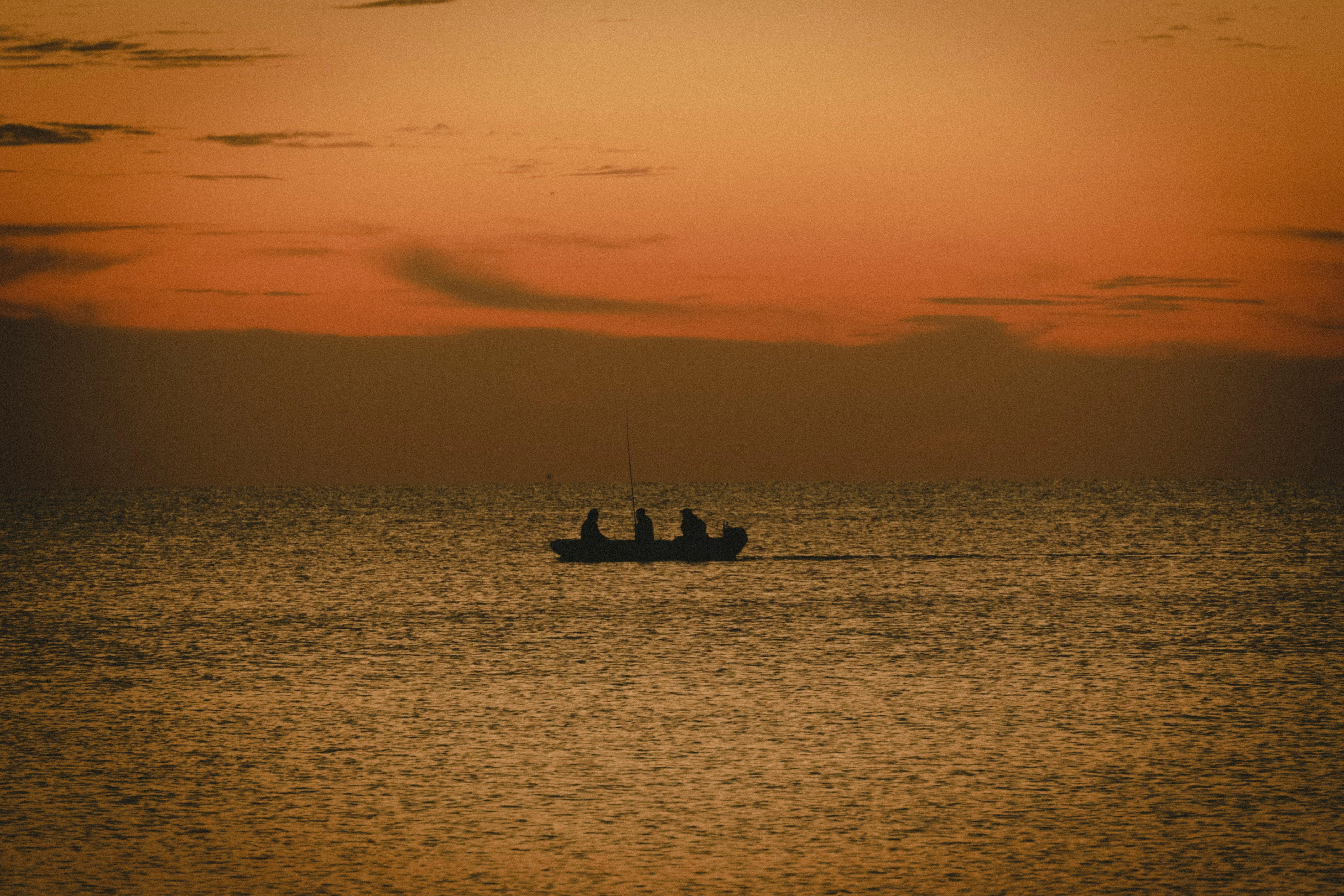 People Sailing on the Sea During Sunset · Free Stock Photo