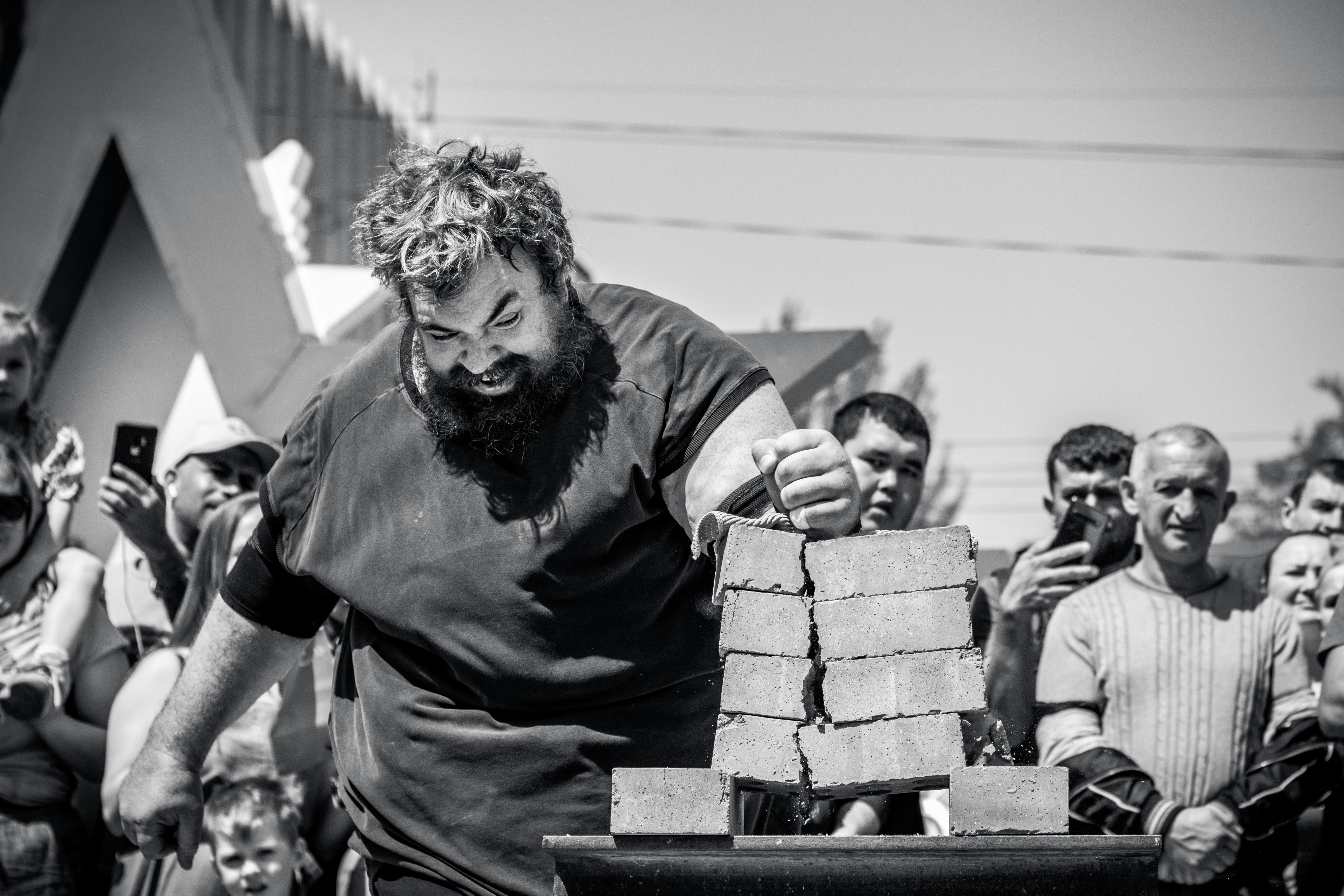Strong Man Smashing Bricks · Free Stock Photo