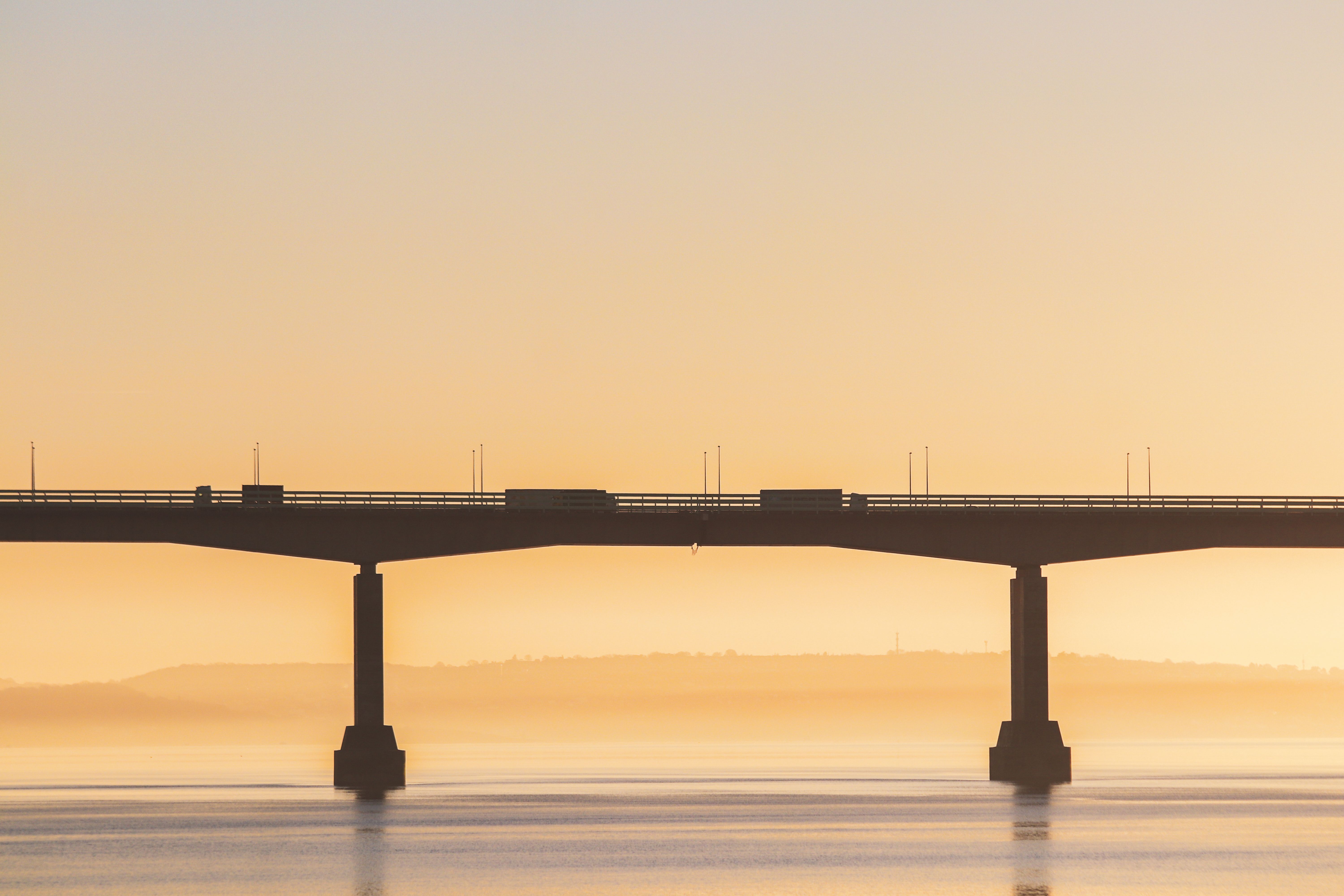 Symmetrical View of a Bridge Silhouette and a River in Yellow Mist ...