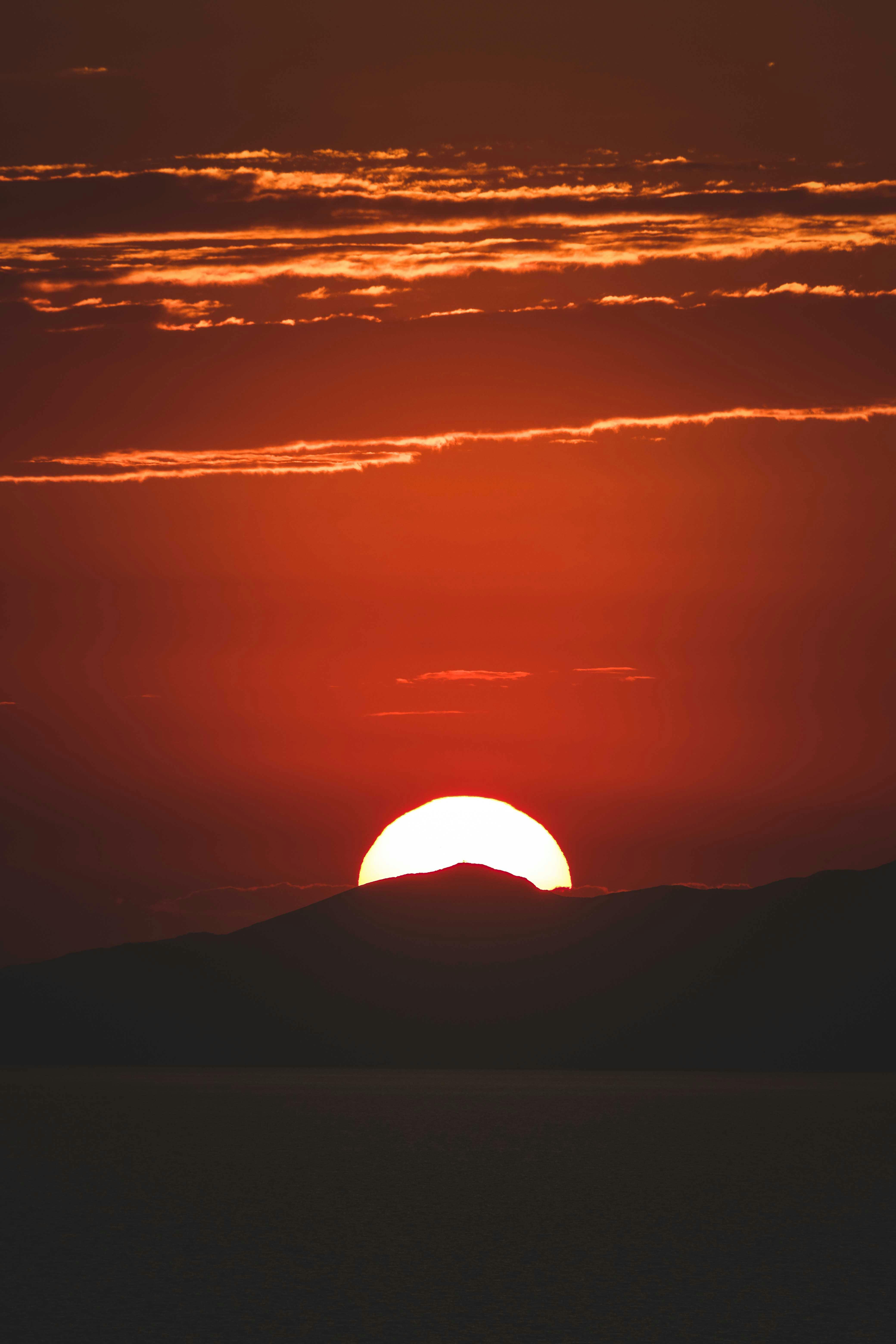 Sunset Over Rock Formation and Sea · Free Stock Photo