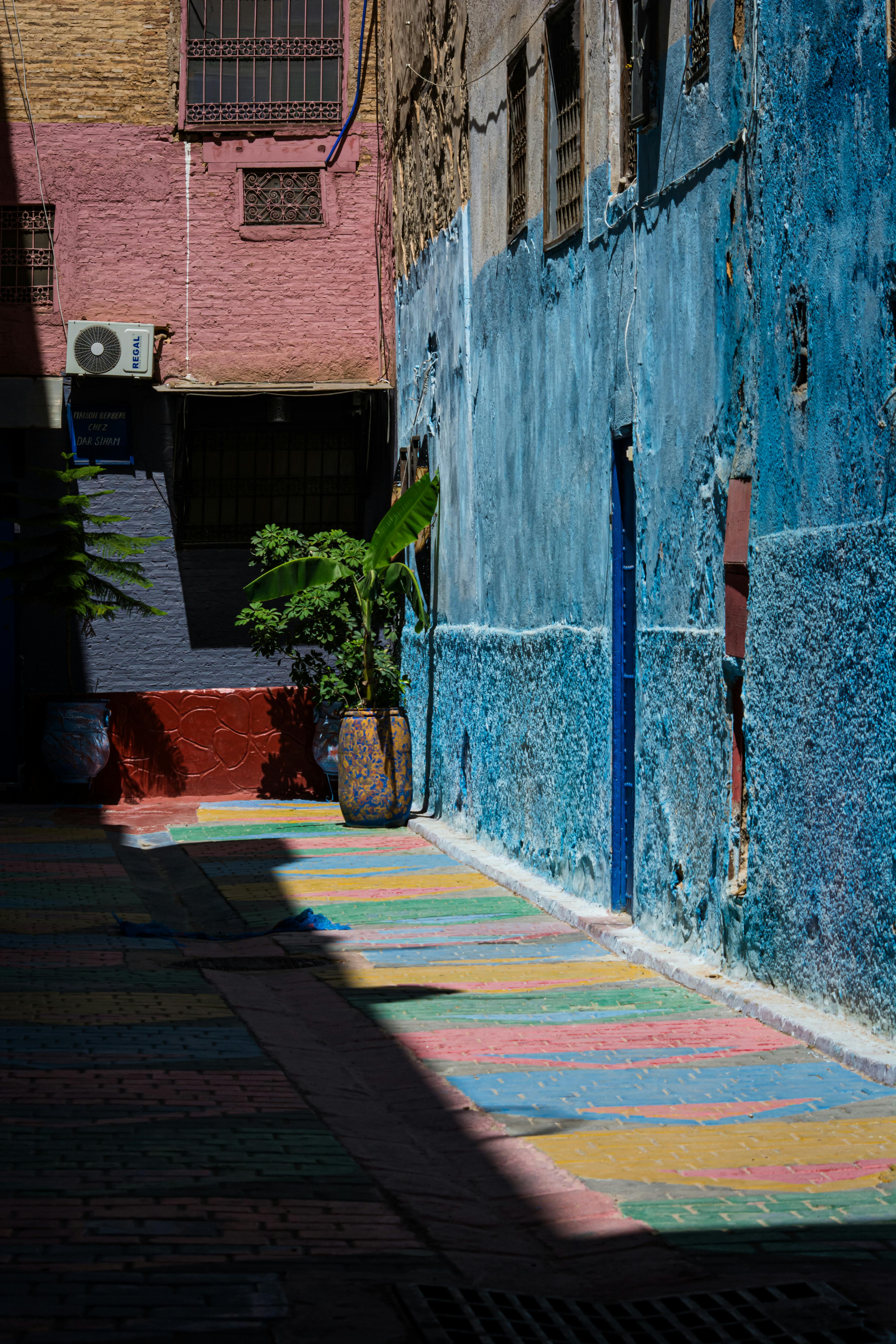 Colorful Pavement near Blue Wall · Free Stock Photo