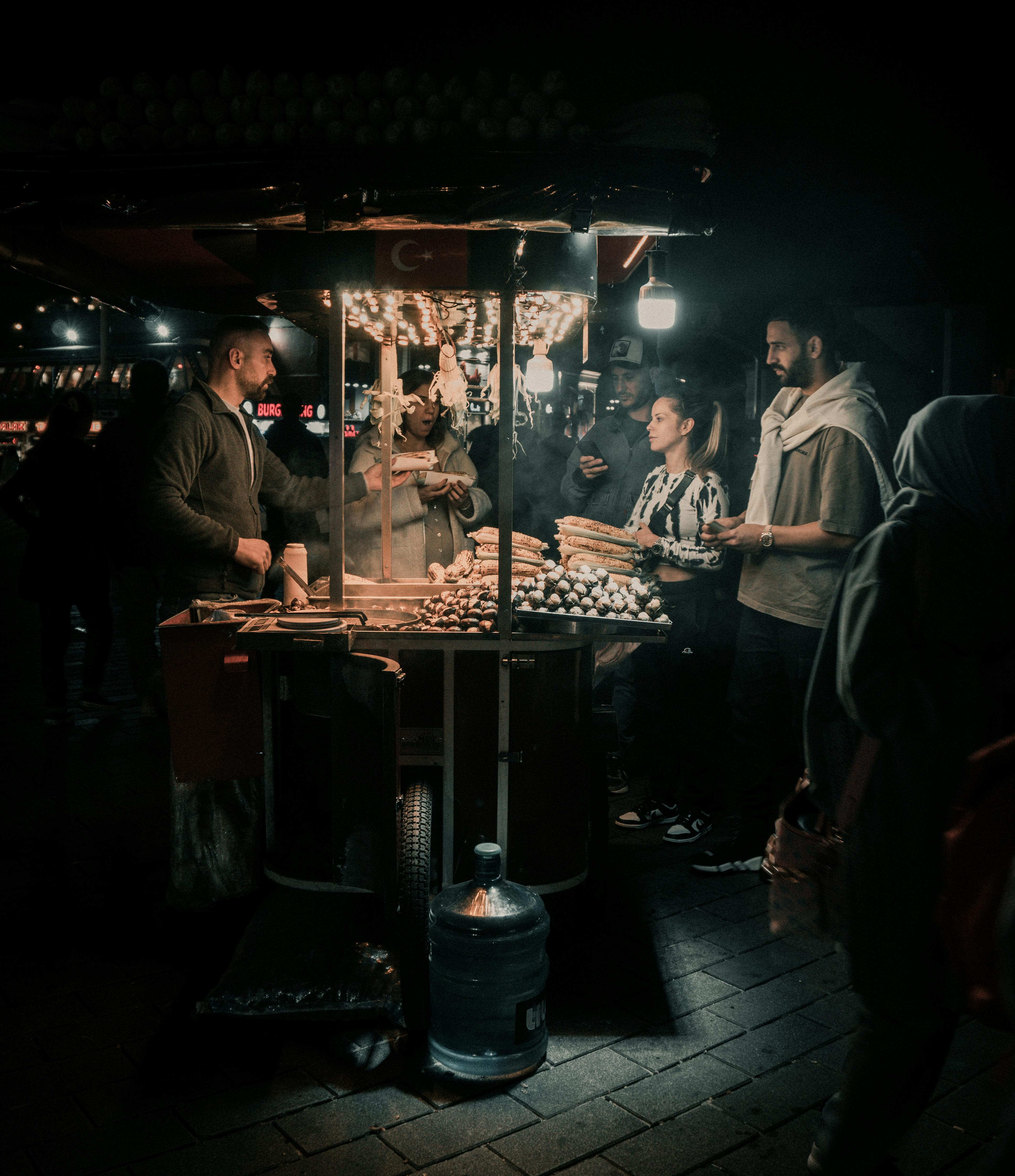 People near Food Stand at Night · Free Stock Photo