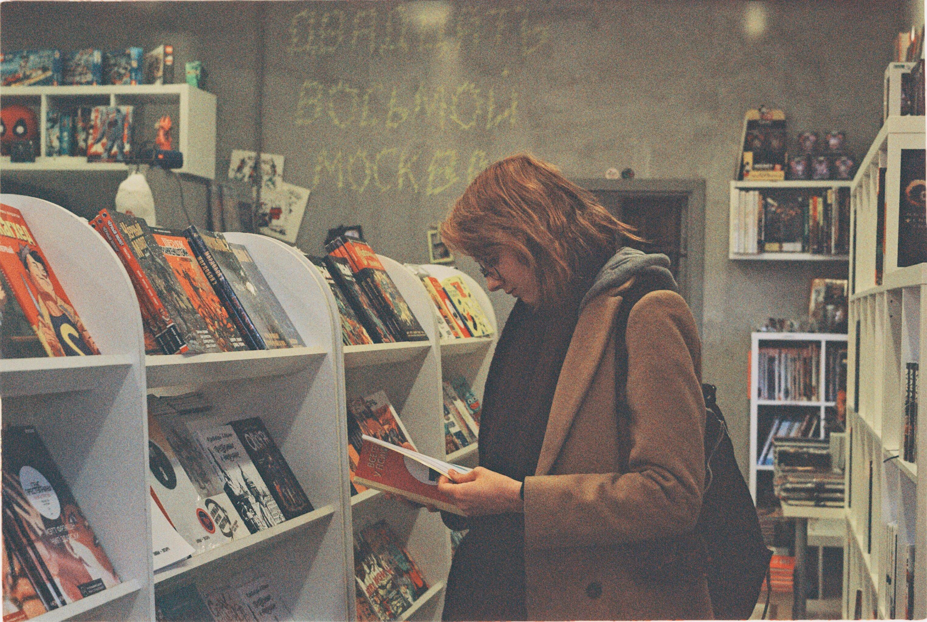 Woman Reading Book on Library · Free Stock Photo