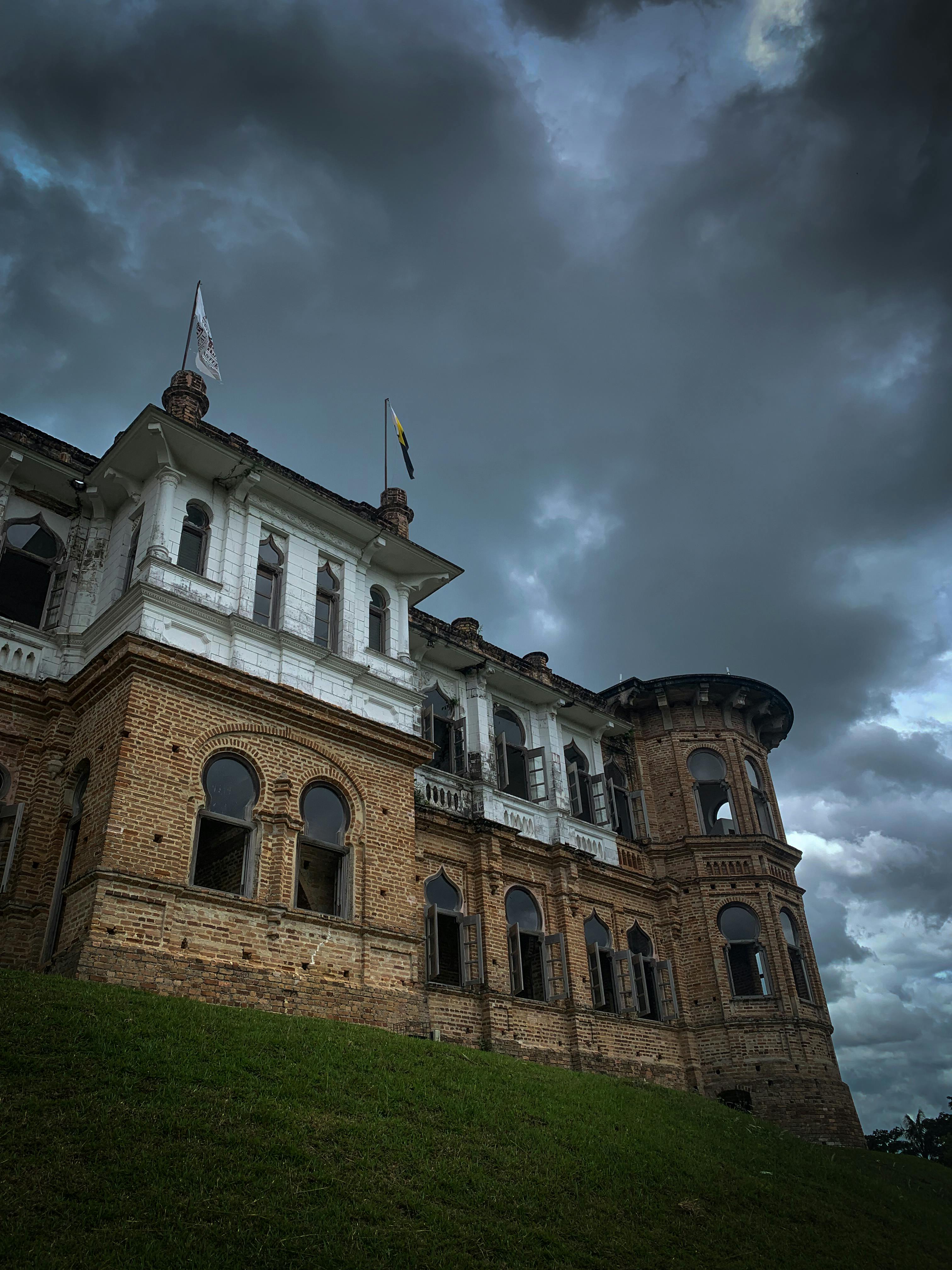 Old Brick Castle on Hill against Cloudy Storm Sky · Free Stock Photo