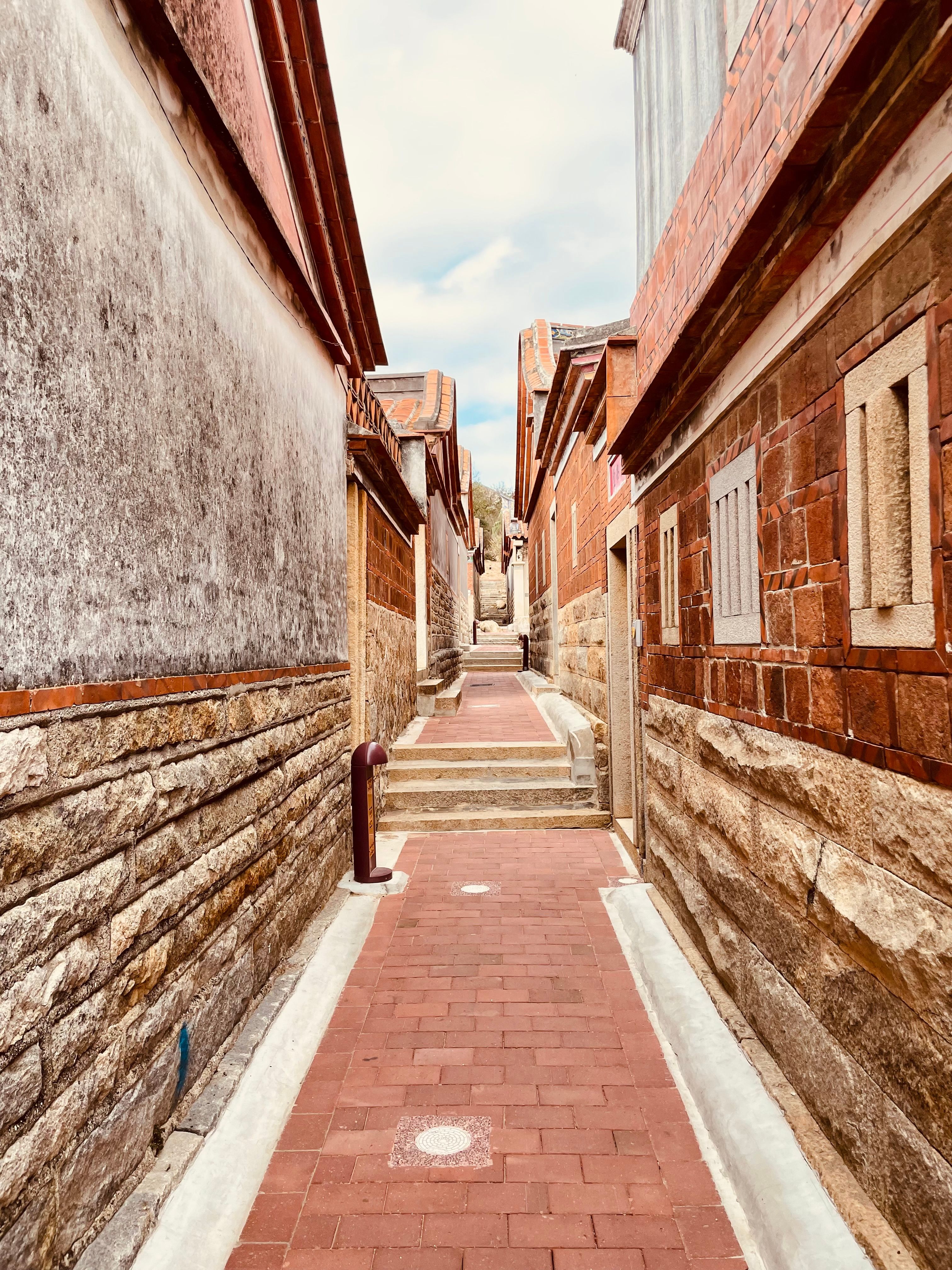 A Narrow Walkway Between Houses · Free Stock Photo