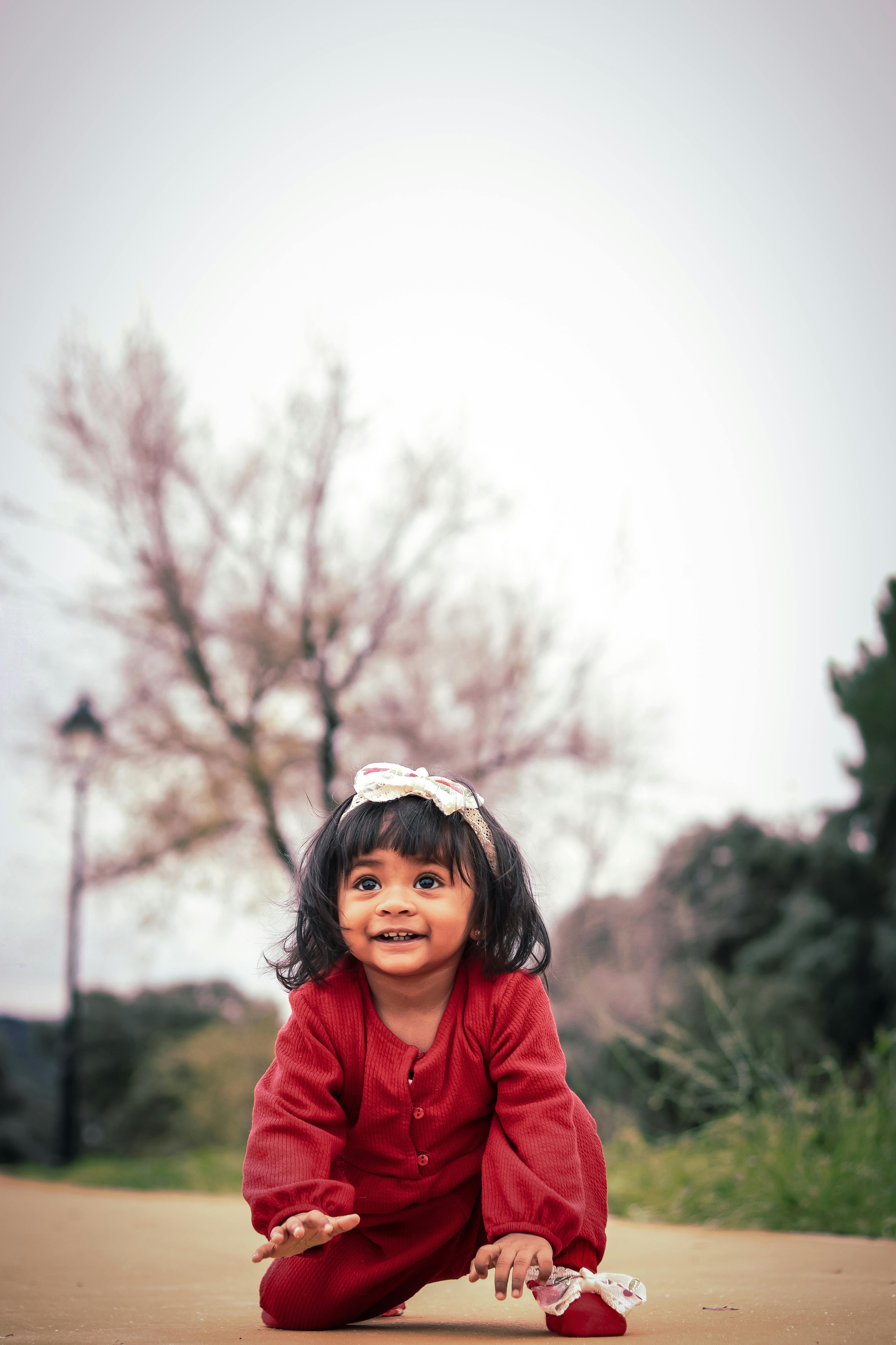 Photo of a Smiling Child in a Red Outfit · Free Stock Photo