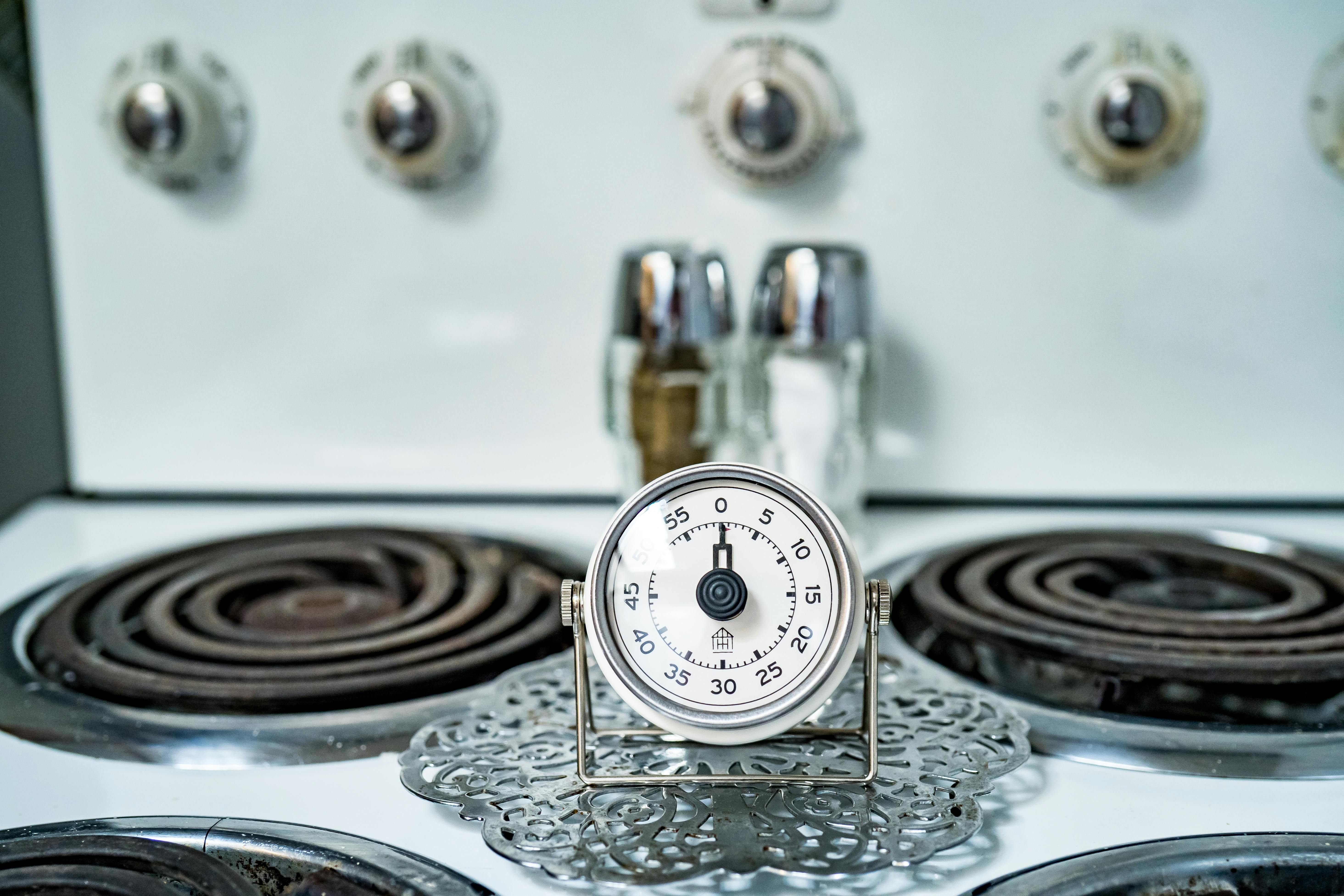Gray Analog Clock on a Wooden Table · Free Stock Photo