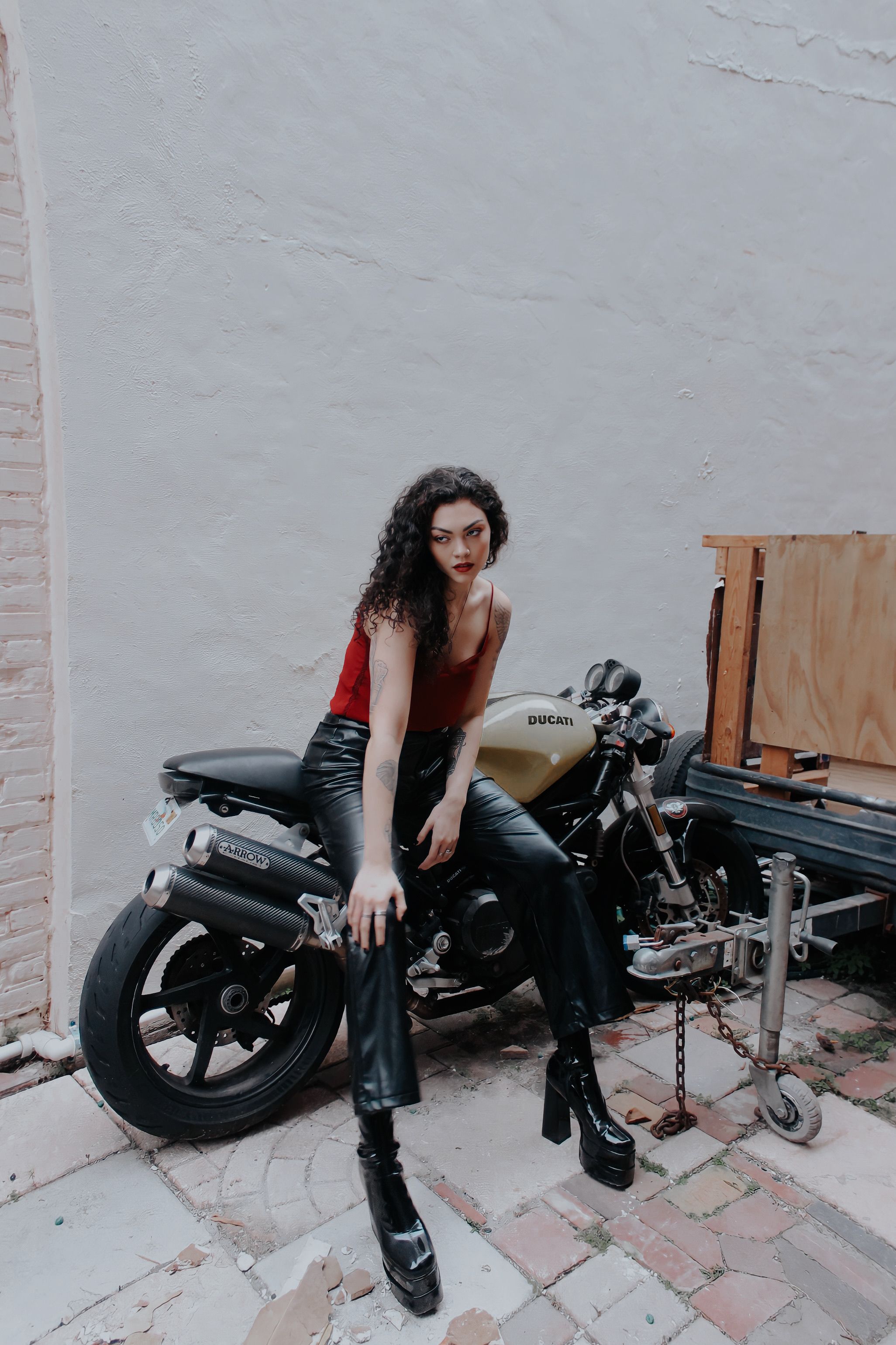 Brunette Woman in Gray Top Posing on Motorcycle · Free Stock Photo