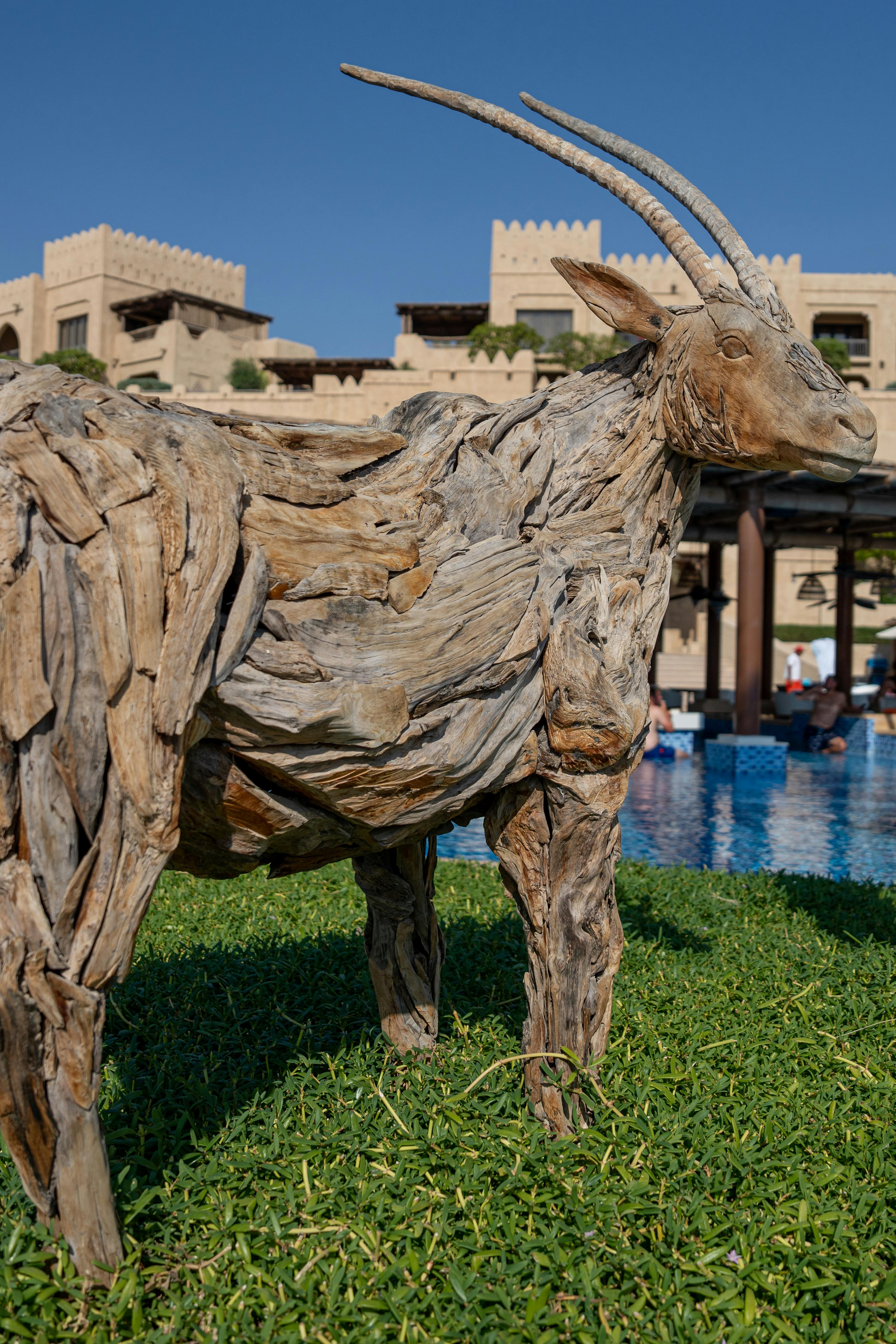 Wooden Goat Figure on the Grass · Free Stock Photo