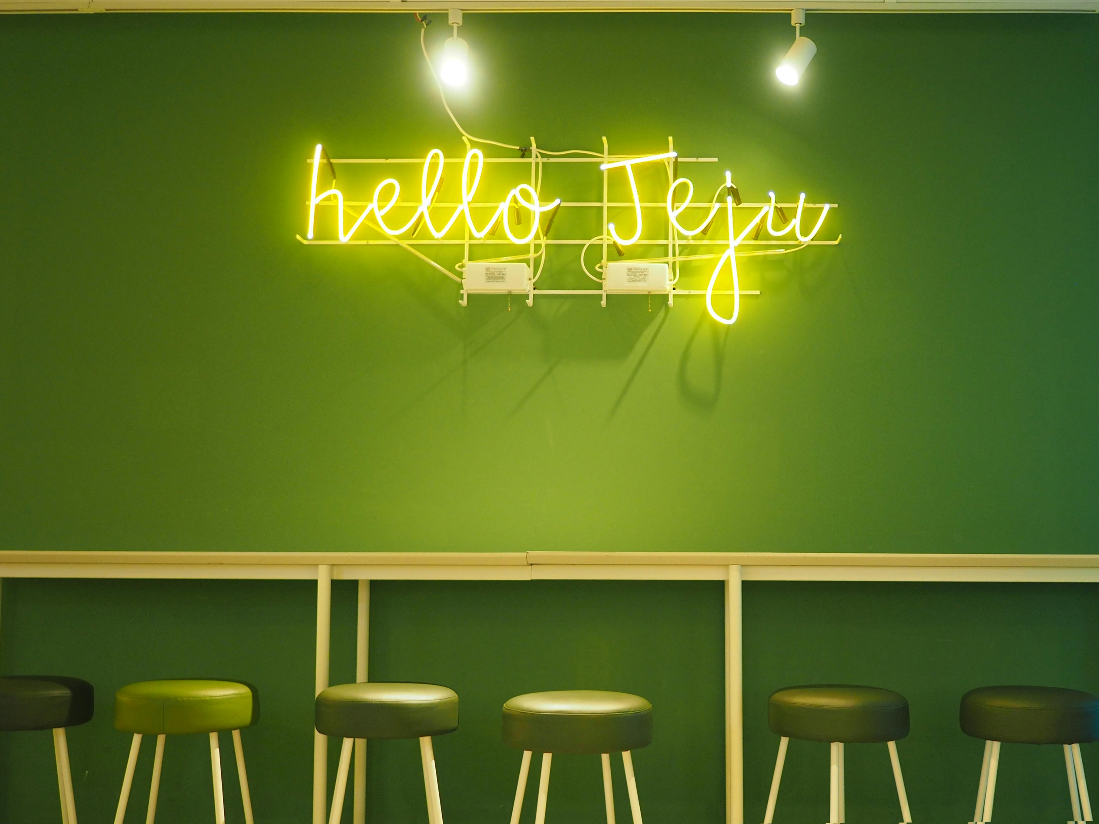 Neon on Green Wall · Free Stock Photo