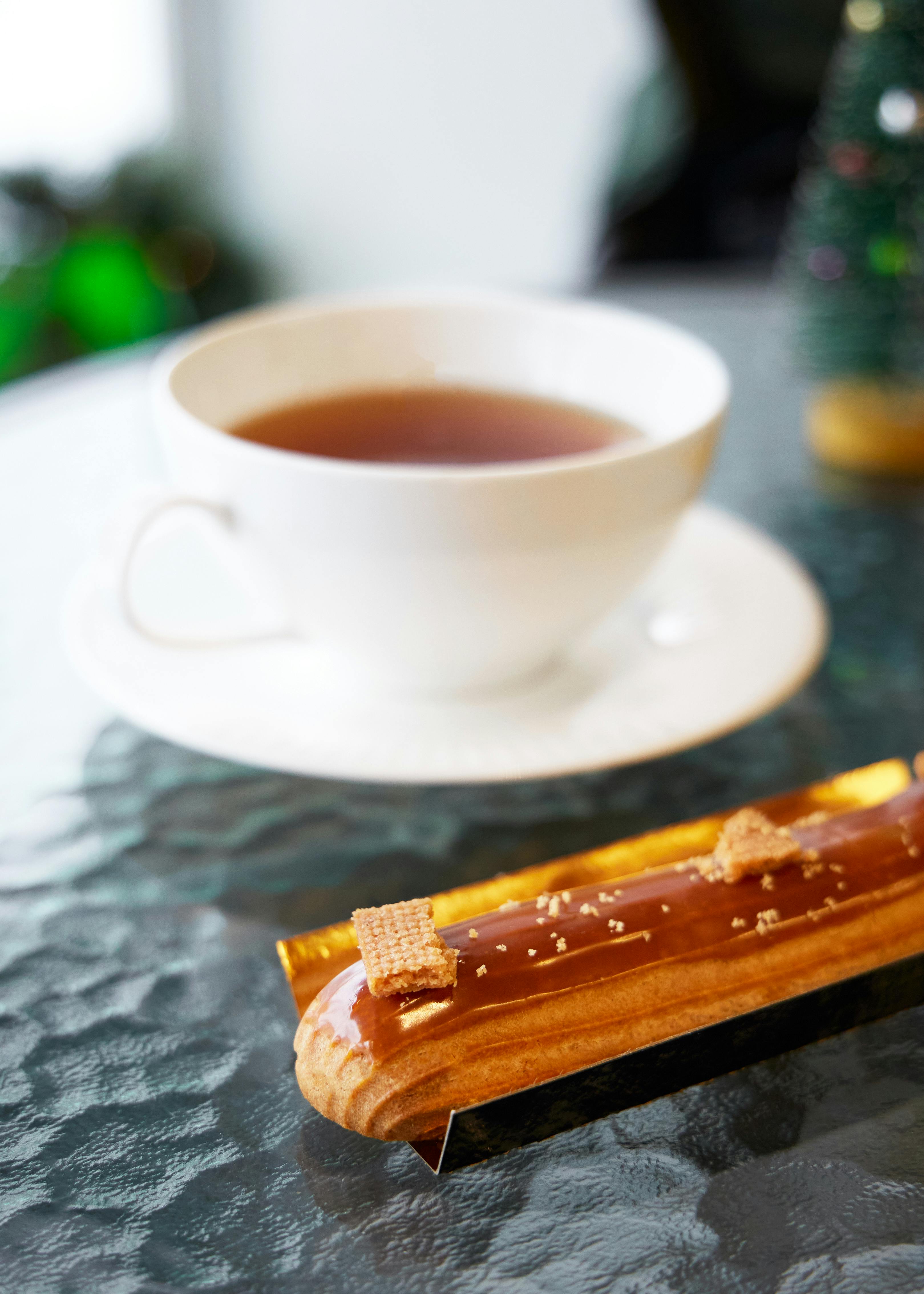 A Cup of Tea with Caramel Eclair on the Side · Free Stock Photo