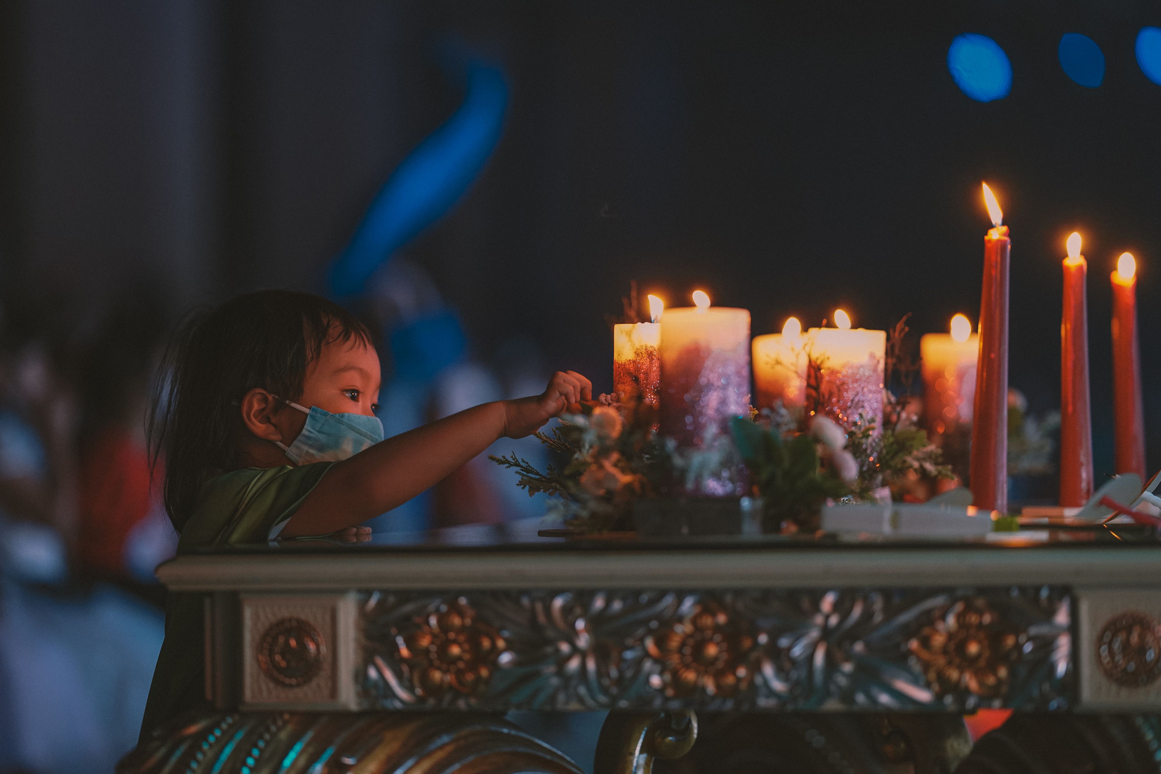 Child and Candles at Ceremony · Free Stock Photo
