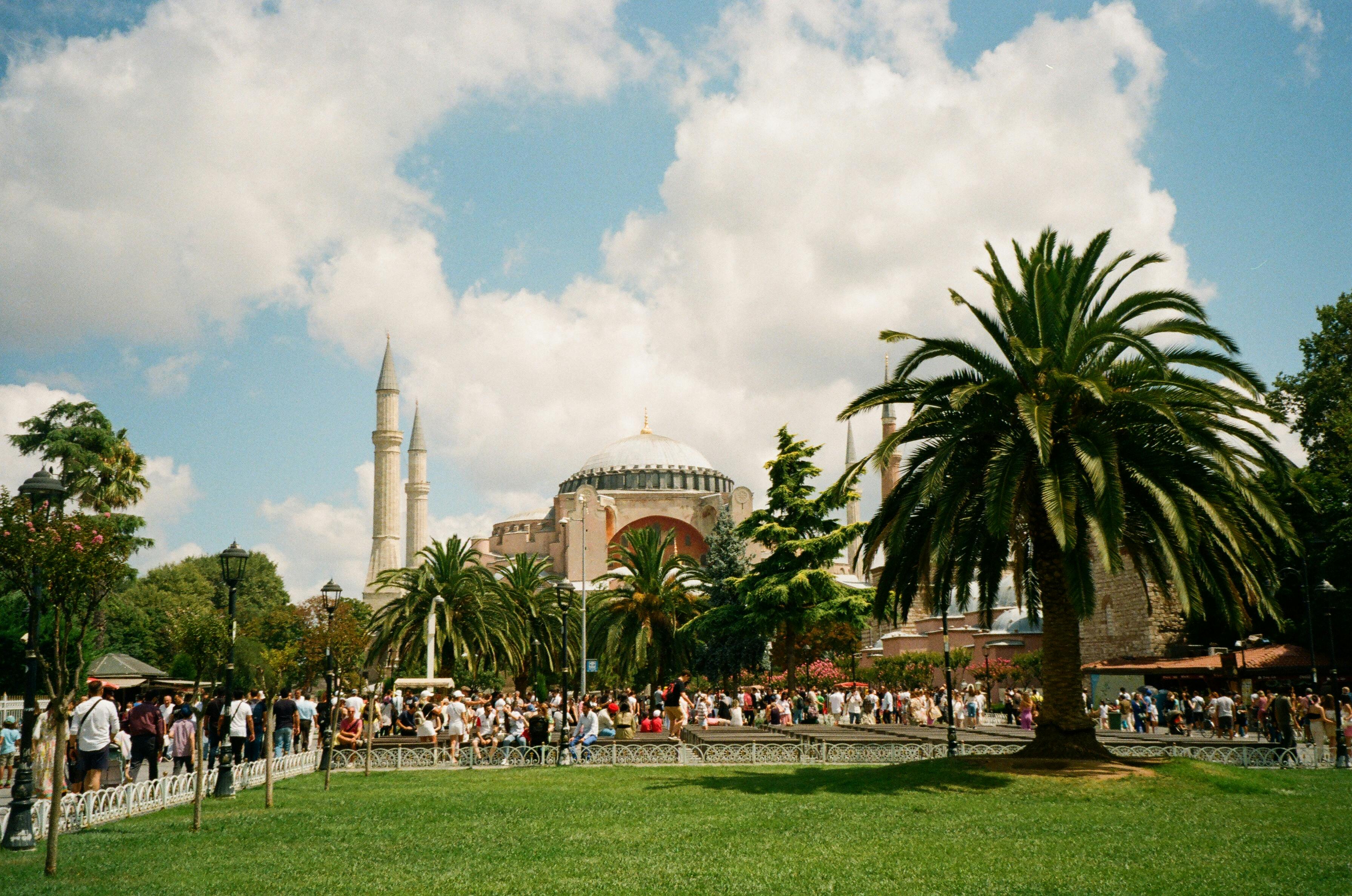 Back View of Tourists Looking at Heritage Architecture · Free Stock Photo
