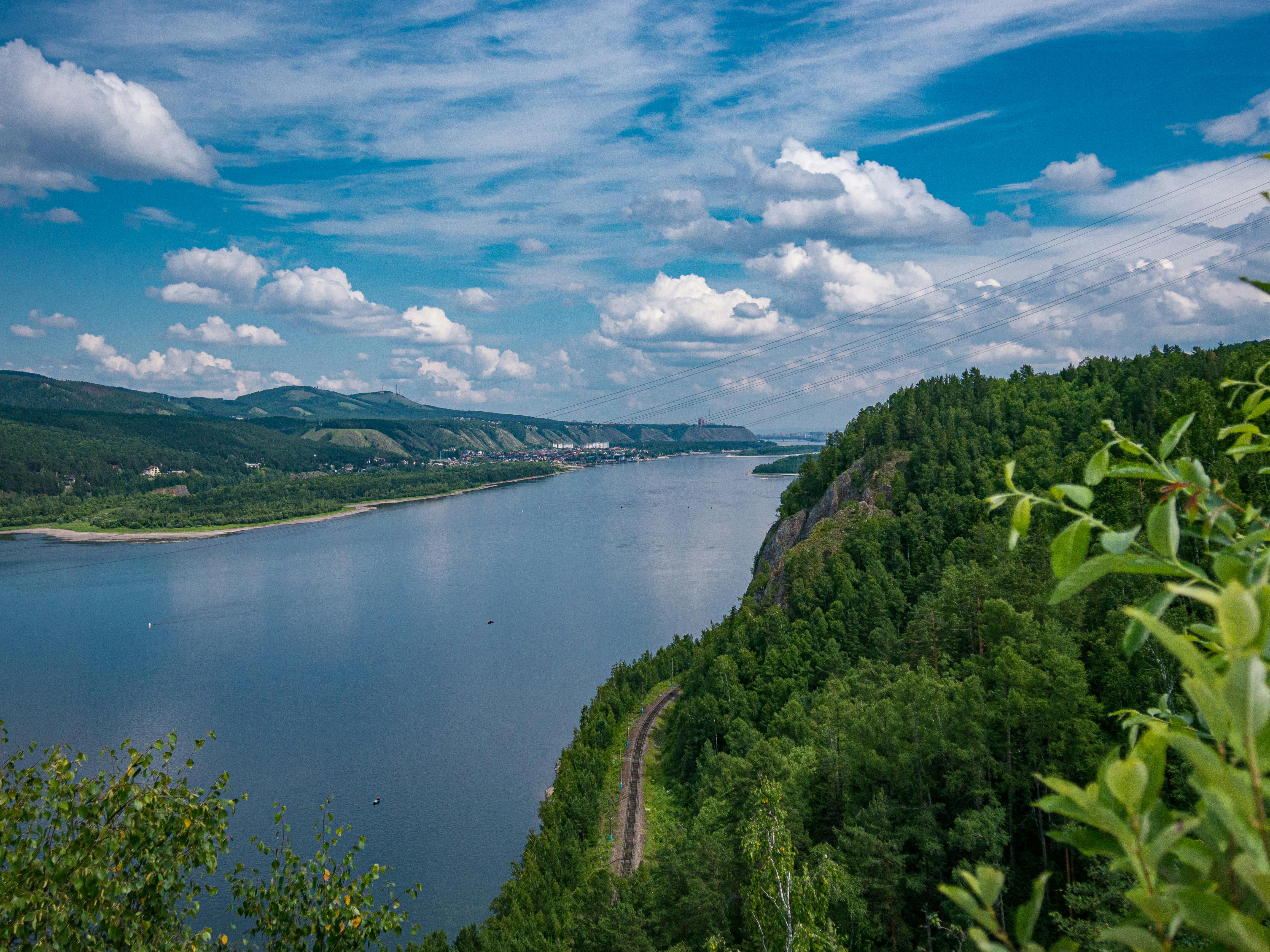 Aerial Photography of Lake between Mountains under the Cloudy Blue Sky ...