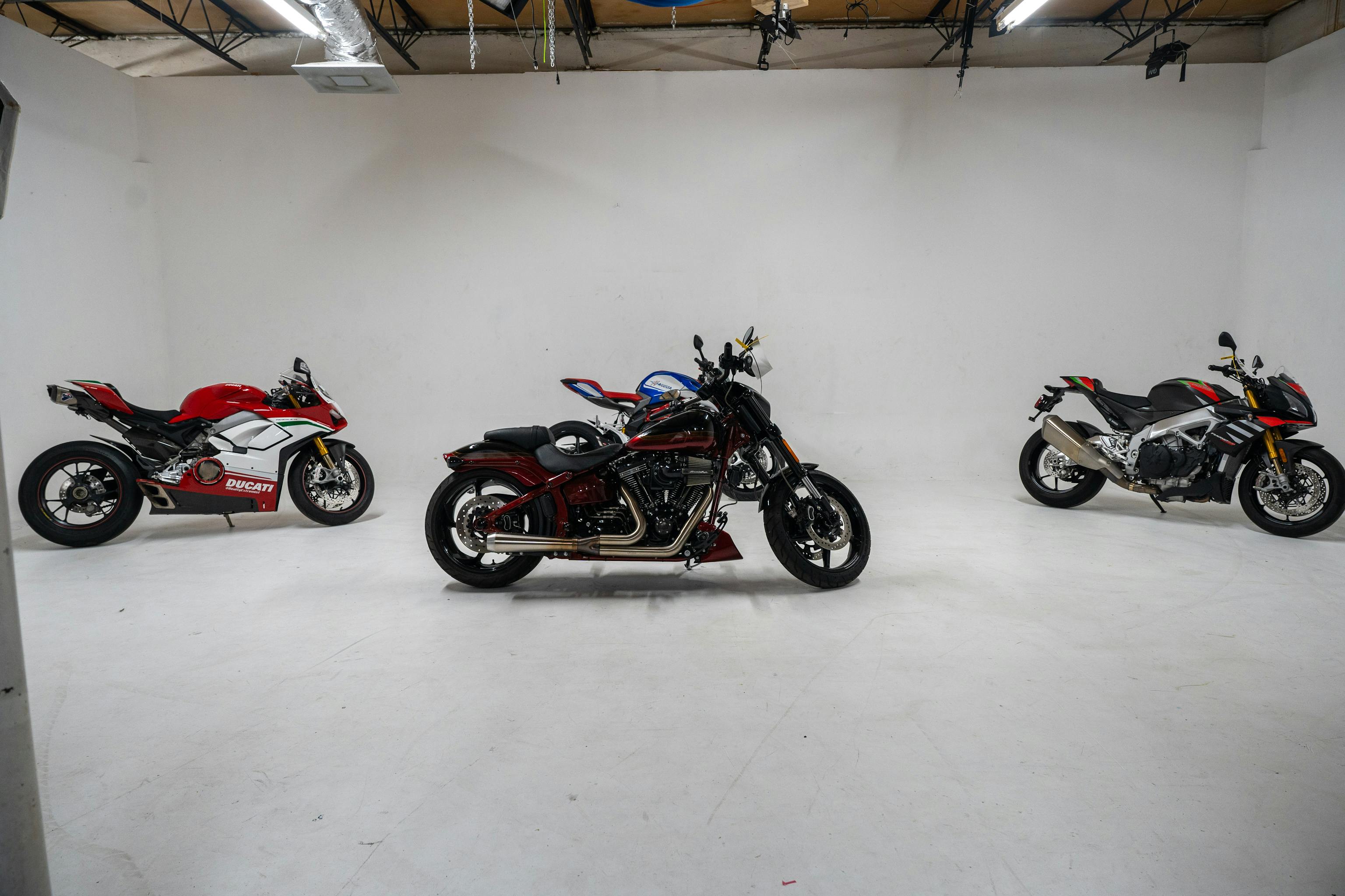 Three Motorcycles in a Studio · Free Stock Photo