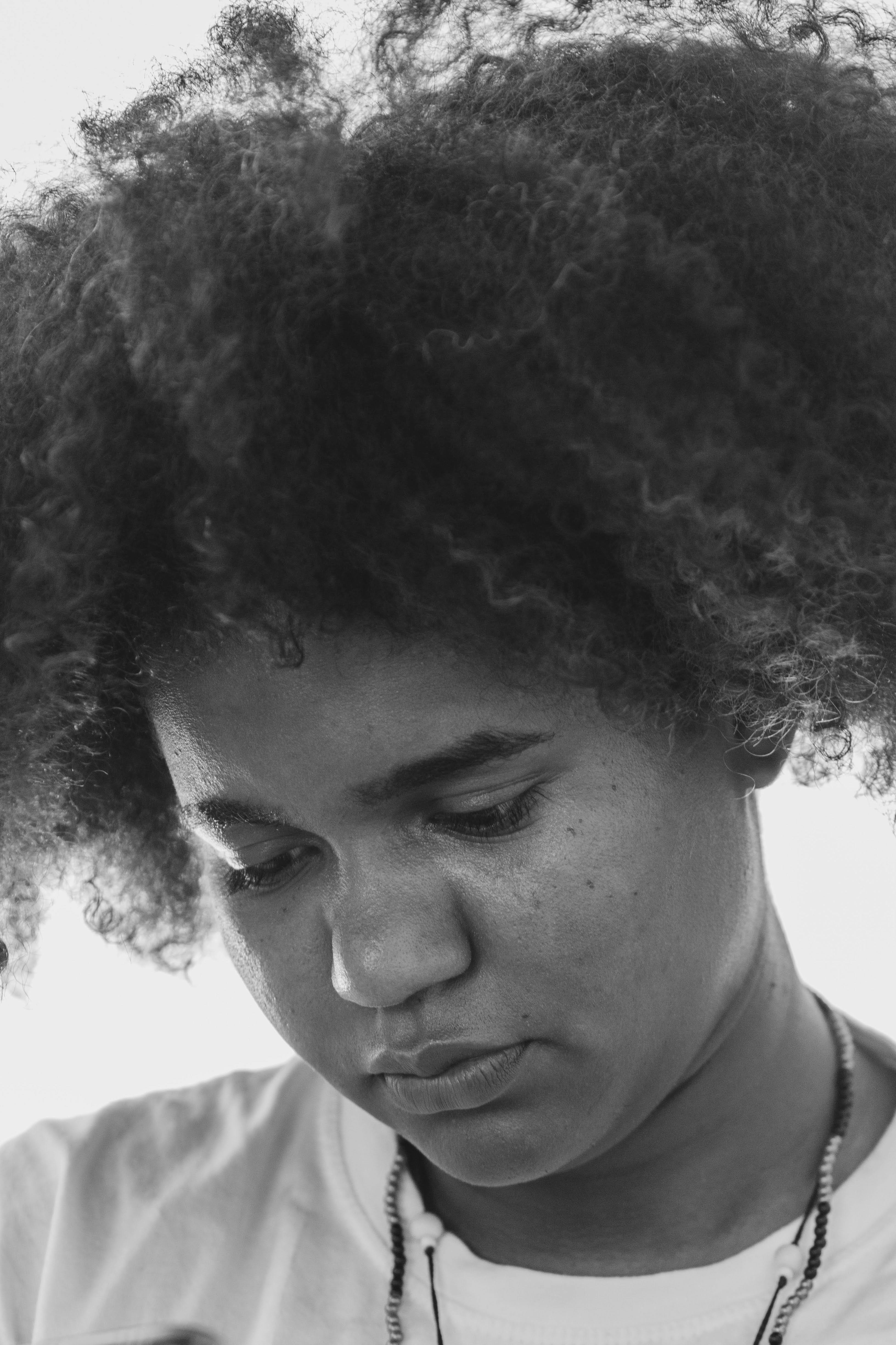 Grayscale Portrait of a Woman Looking Pensive · Free Stock Photo